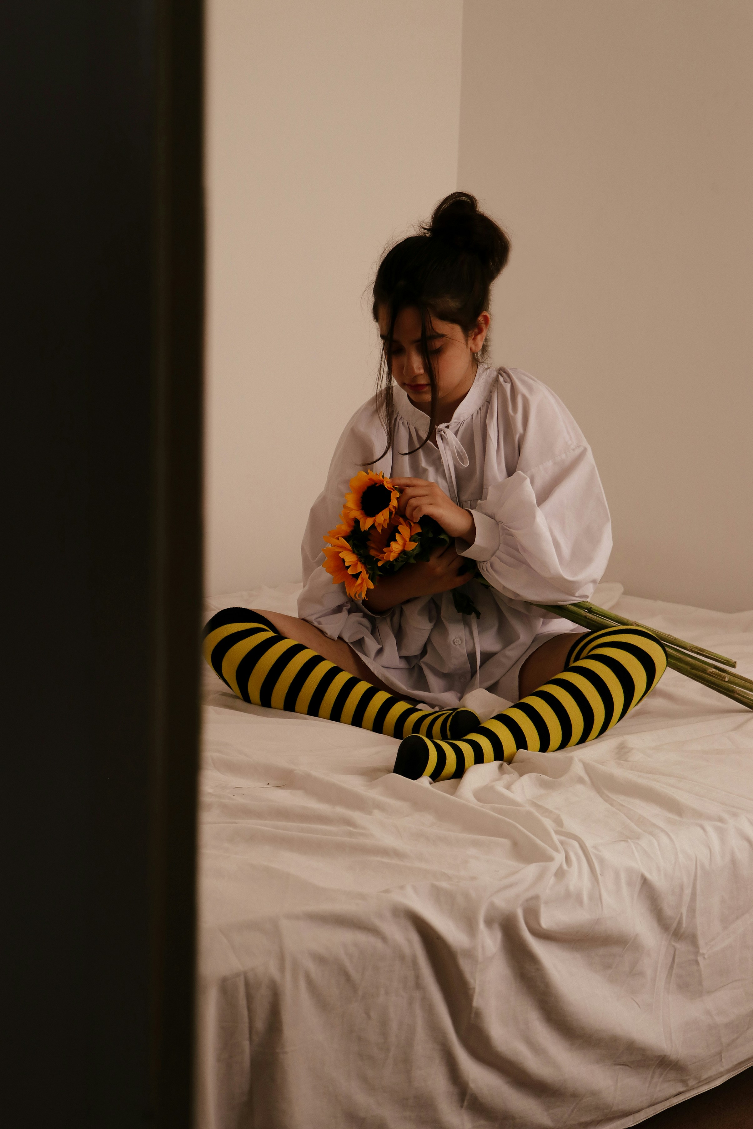 Sunflowers and Stripes: a soft-lit bedroom portrait