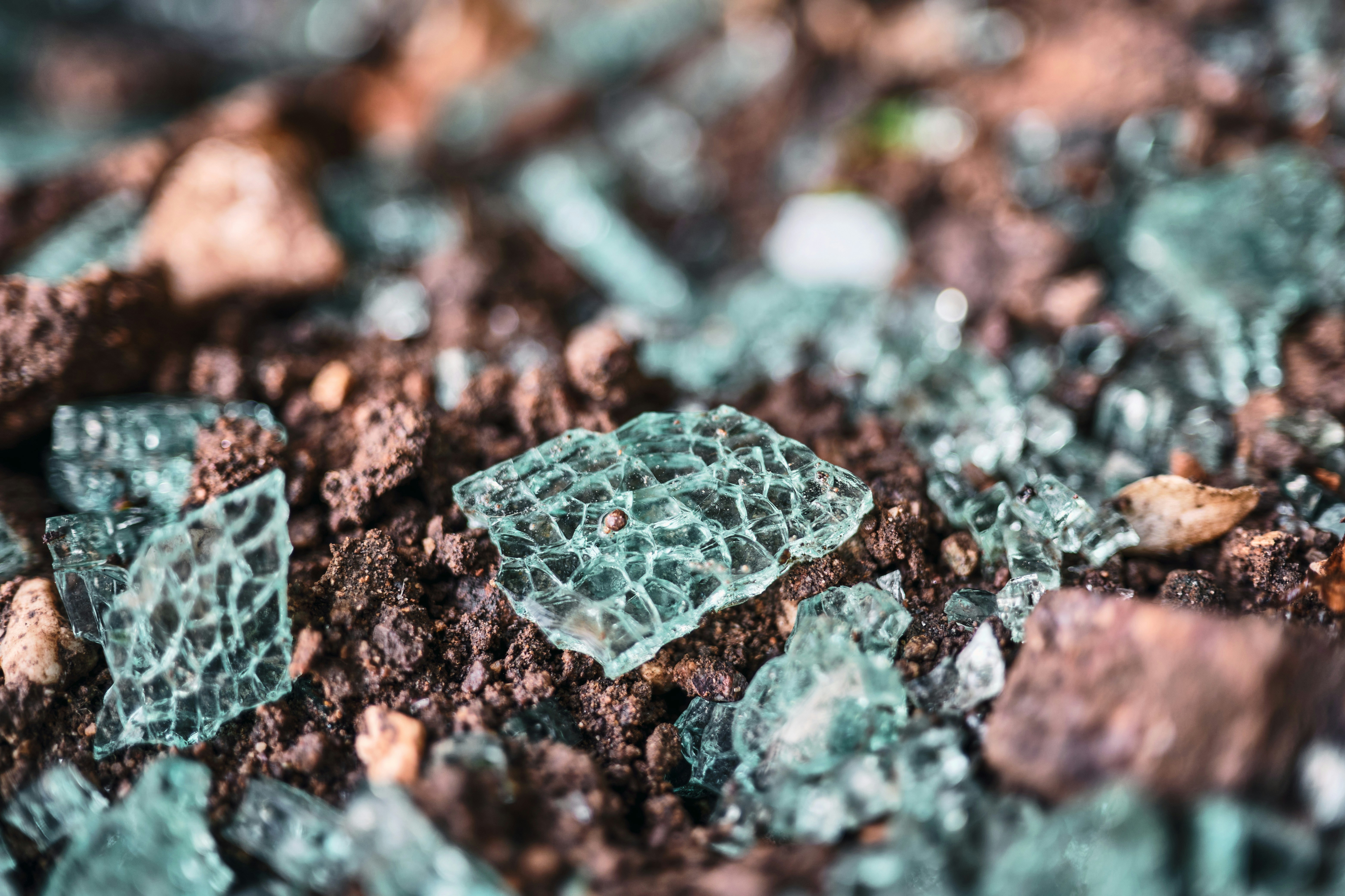 Shattered Teal Fragments: Microtexture Amidst Brown Soil