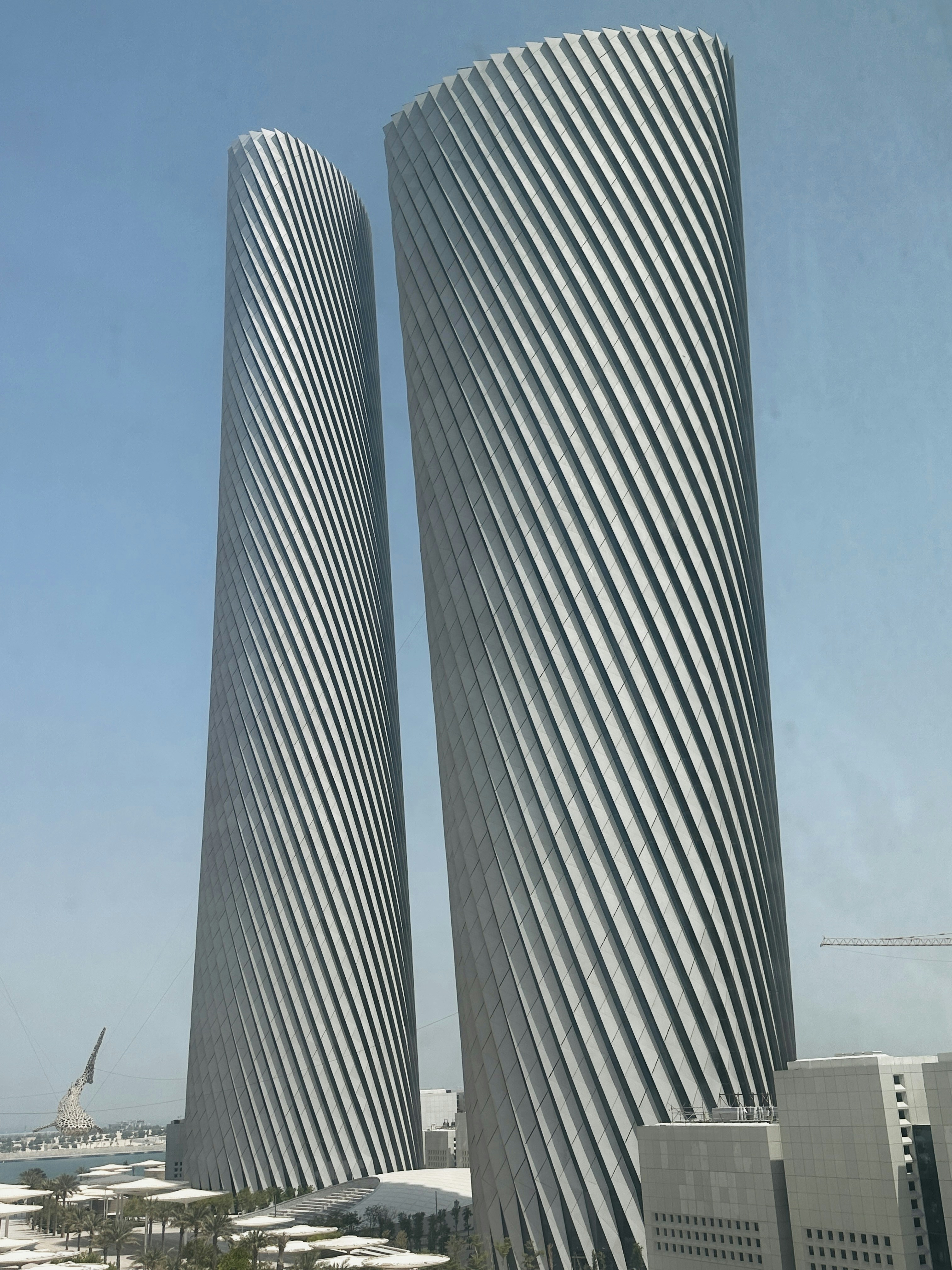 A couple of tall buildings sitting next to each other photo – Free ...