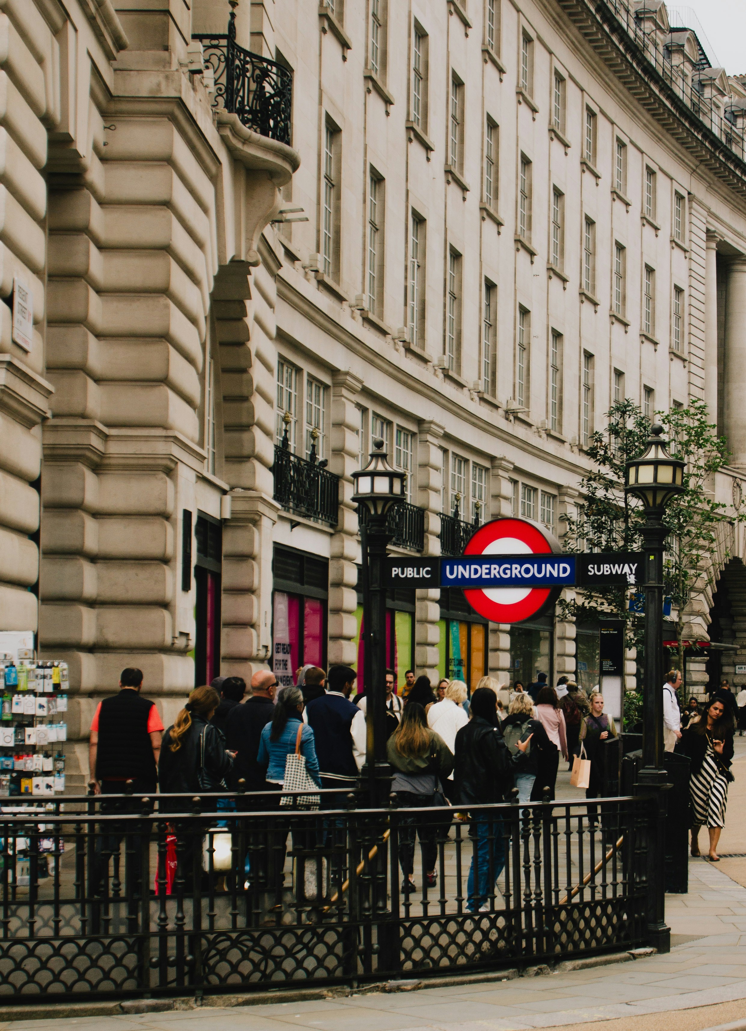A group of people standing outside of a building photo – Free Street ...