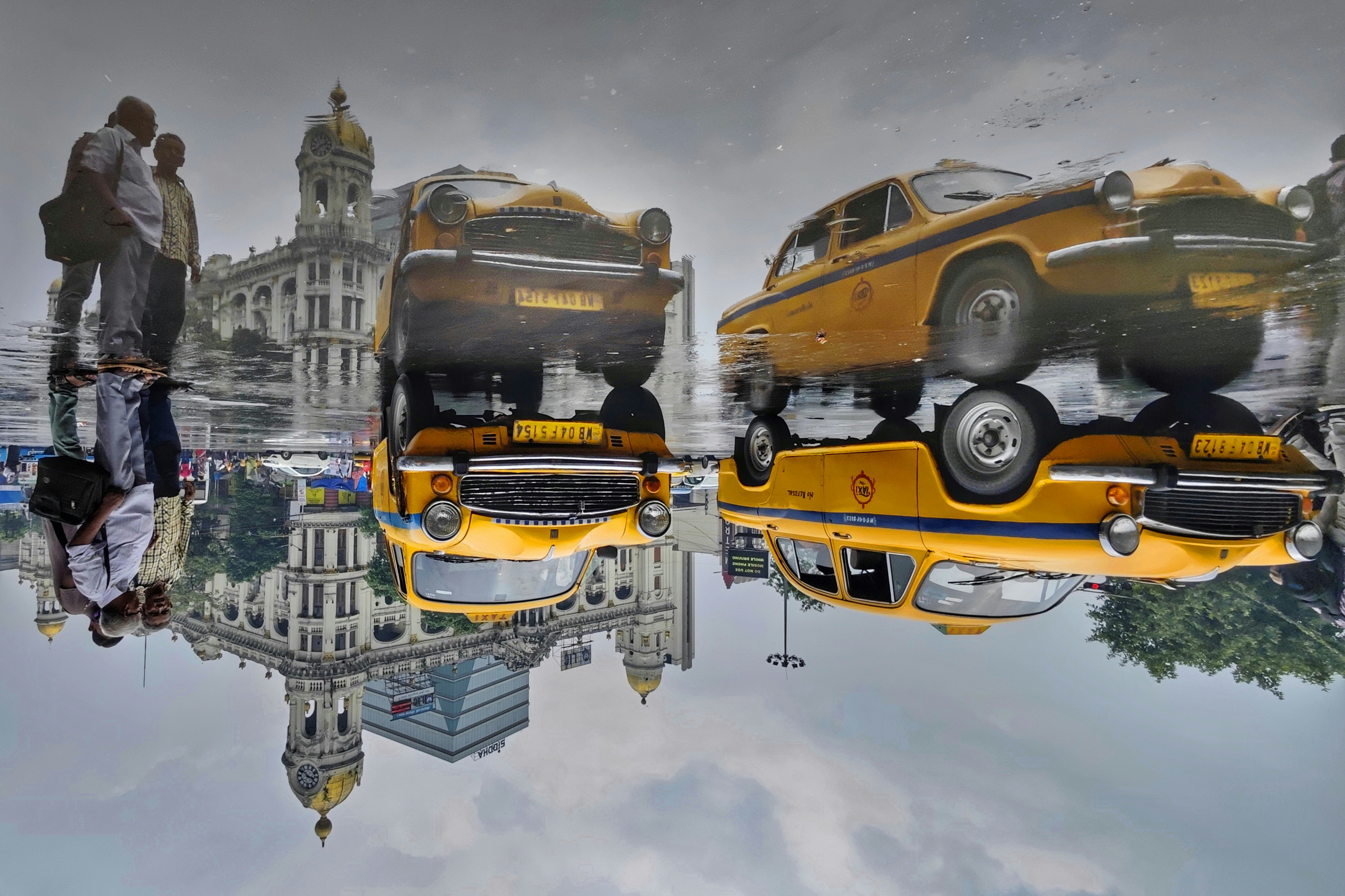 A reflection of two cars in a puddle of water photo – Free Kolkata ...