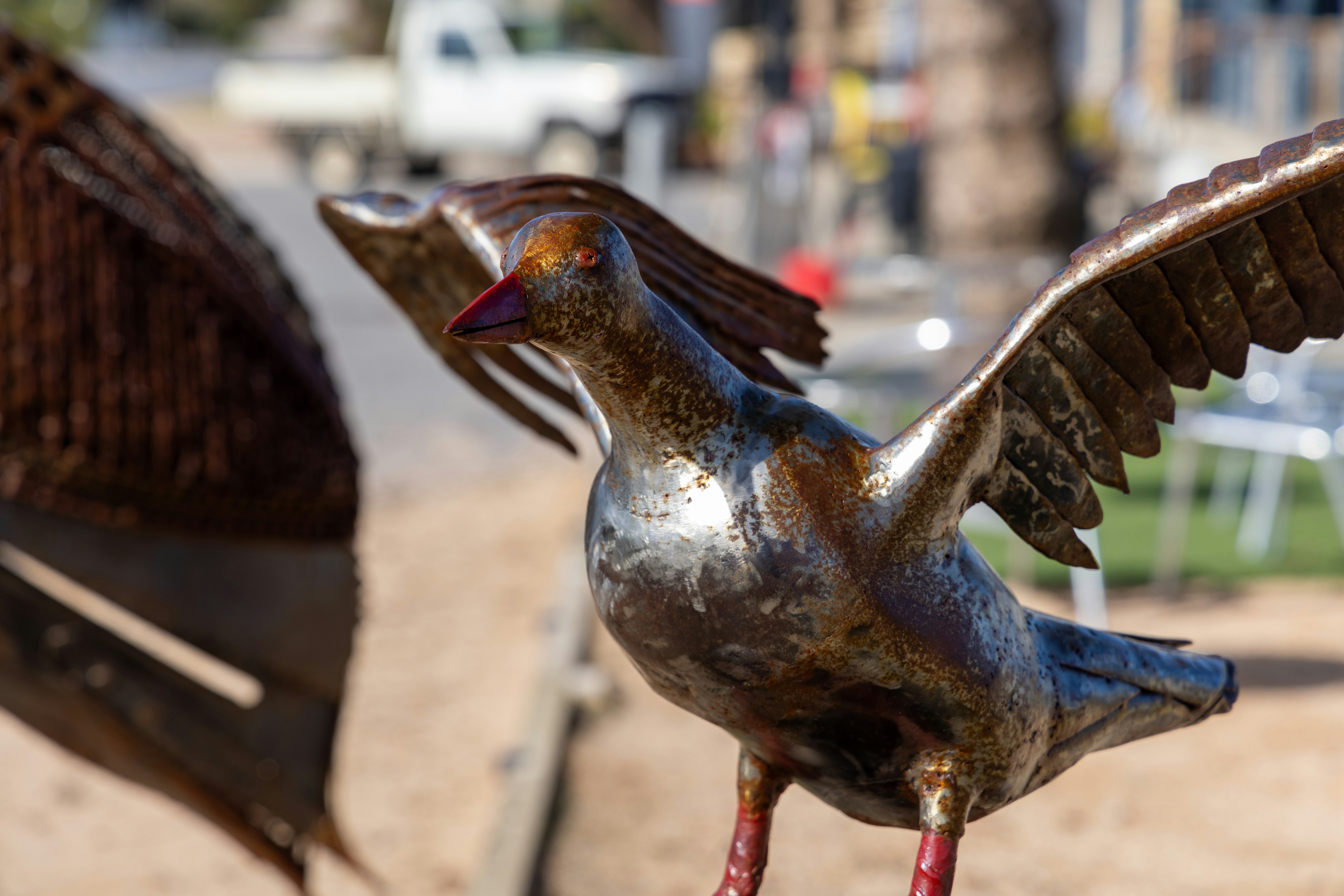 Rusting sentinel: a metal seabird frozen in mid-wing