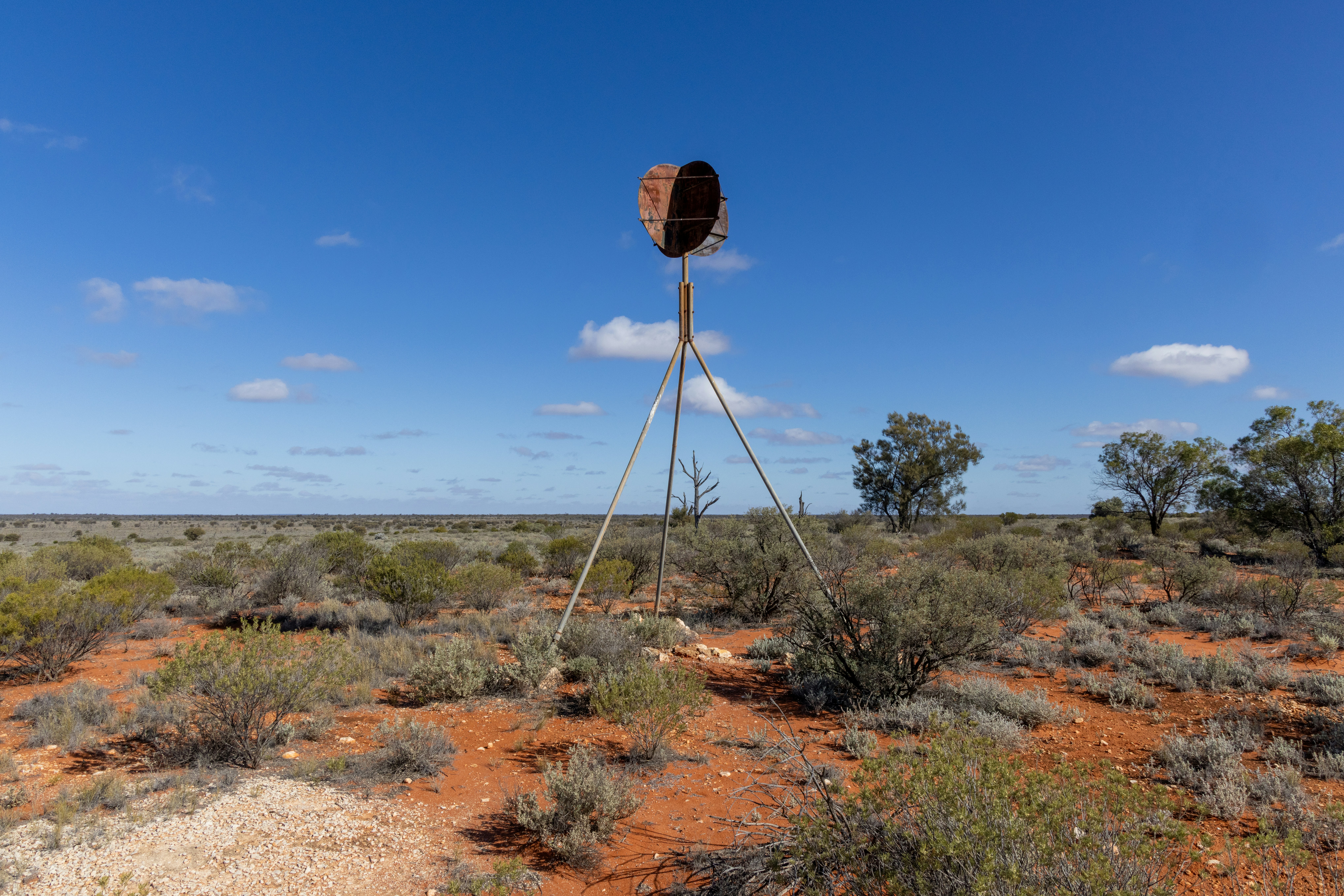 Desert Signal: A Weathered Windmarker Stands Against the Flat Horizon