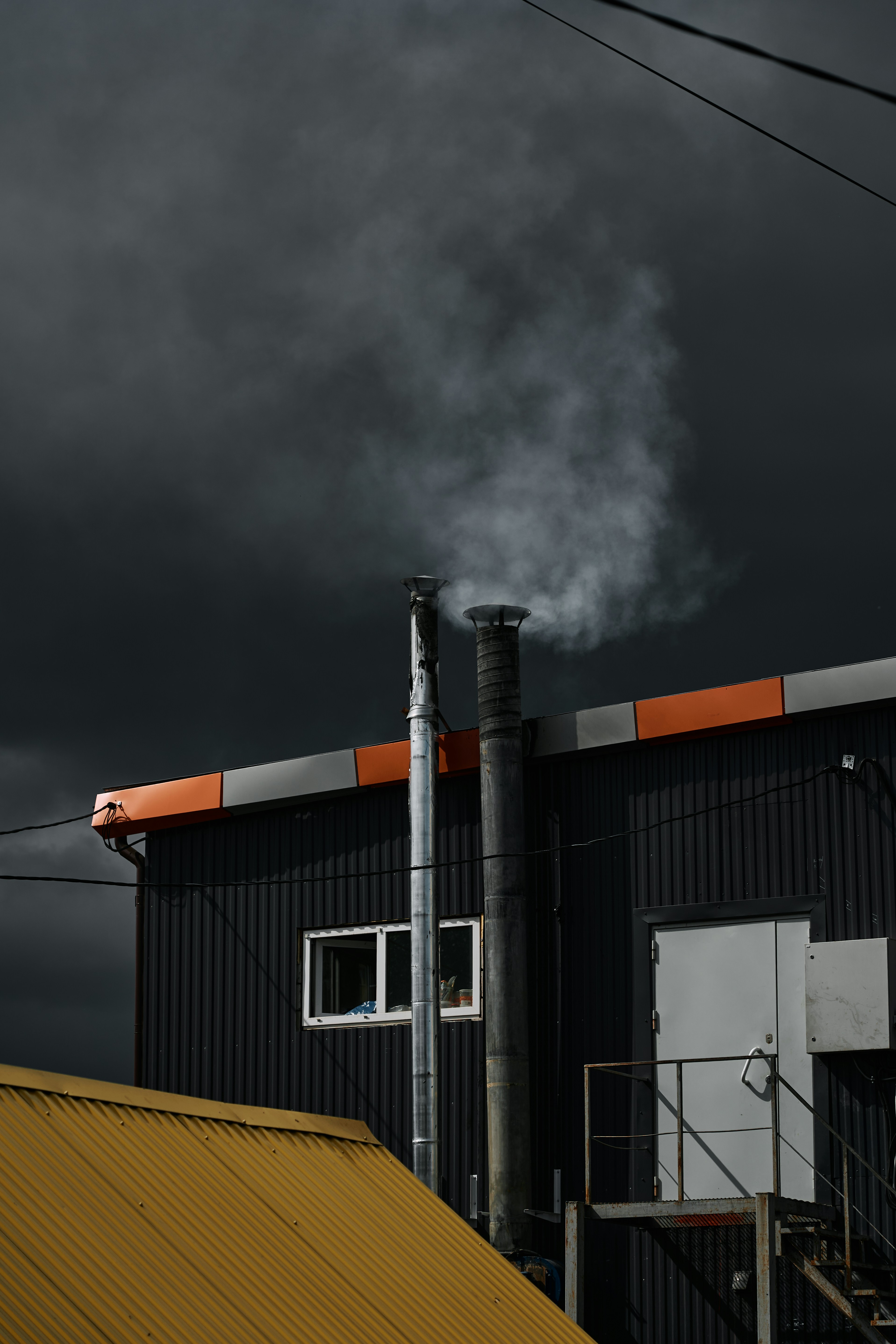 Smokestacks and Steam Against a Stormy Sky