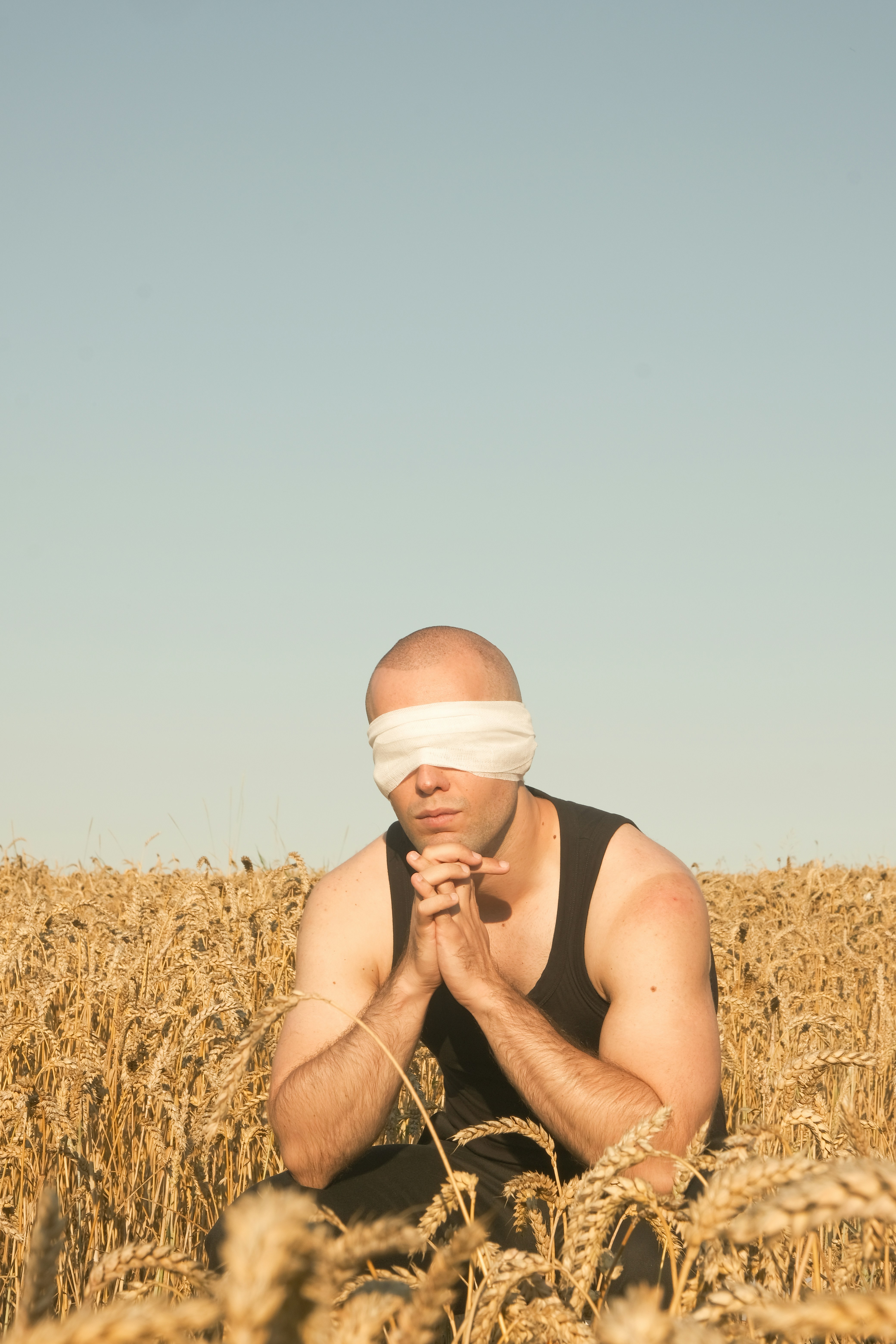 Blindfolded in the Wheat Field: A Quiet Moment of Contemplation