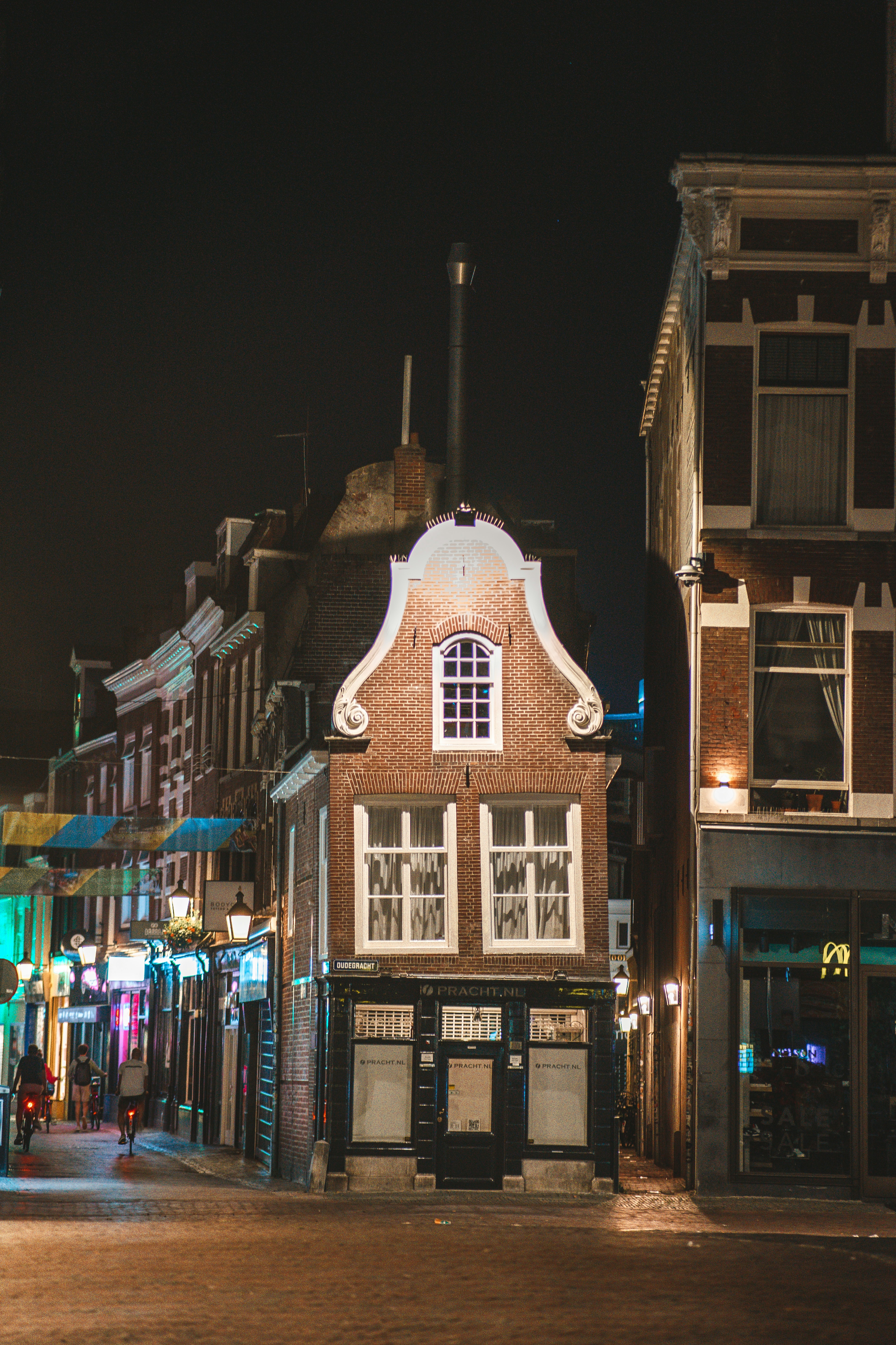 Arc of Brick and Light: Night Portrait of a Curved-Gable Townhouse