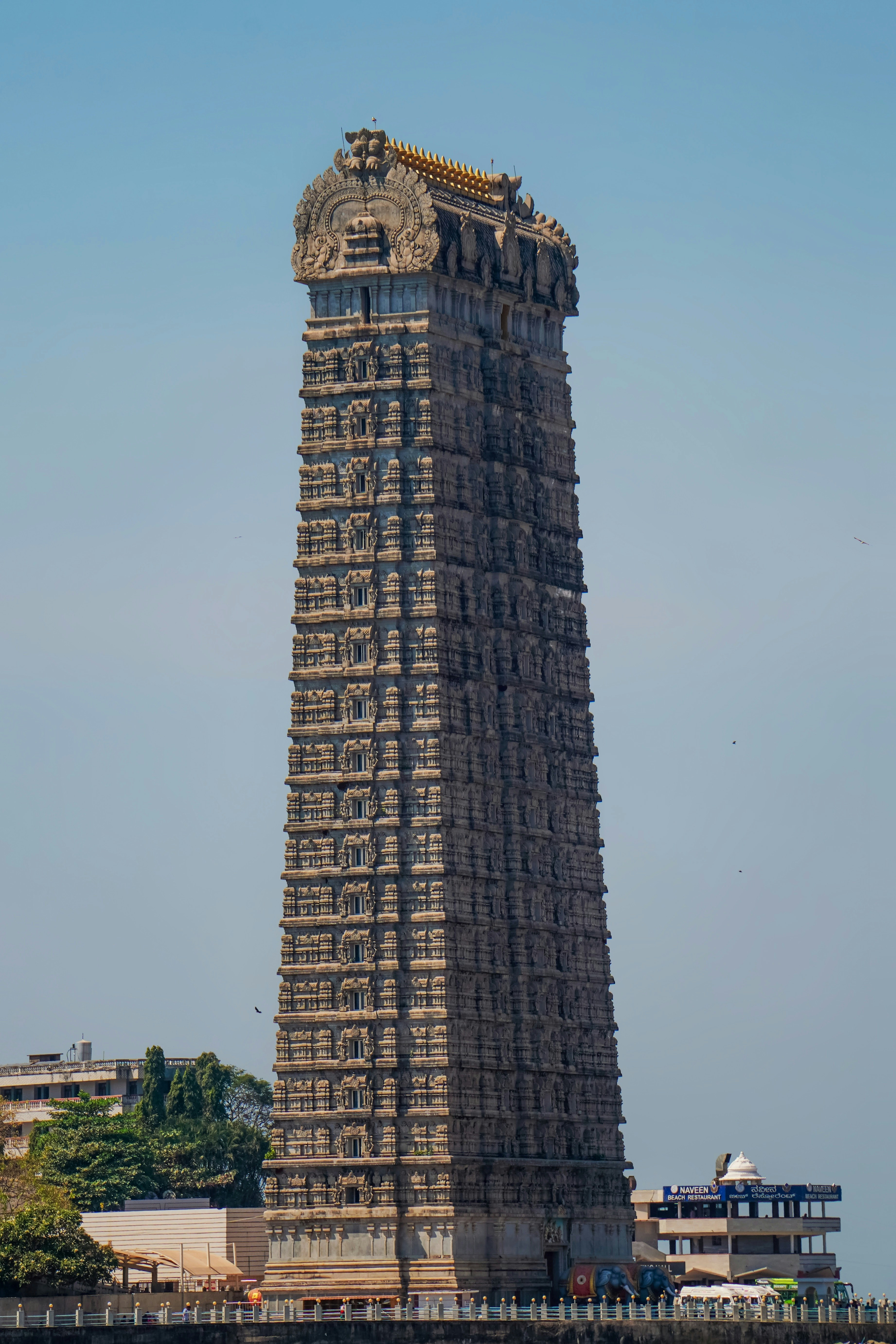 Harbor Sentinel: The Carved Stone Pillar Reaching Up Against a Clear Blue Sky
