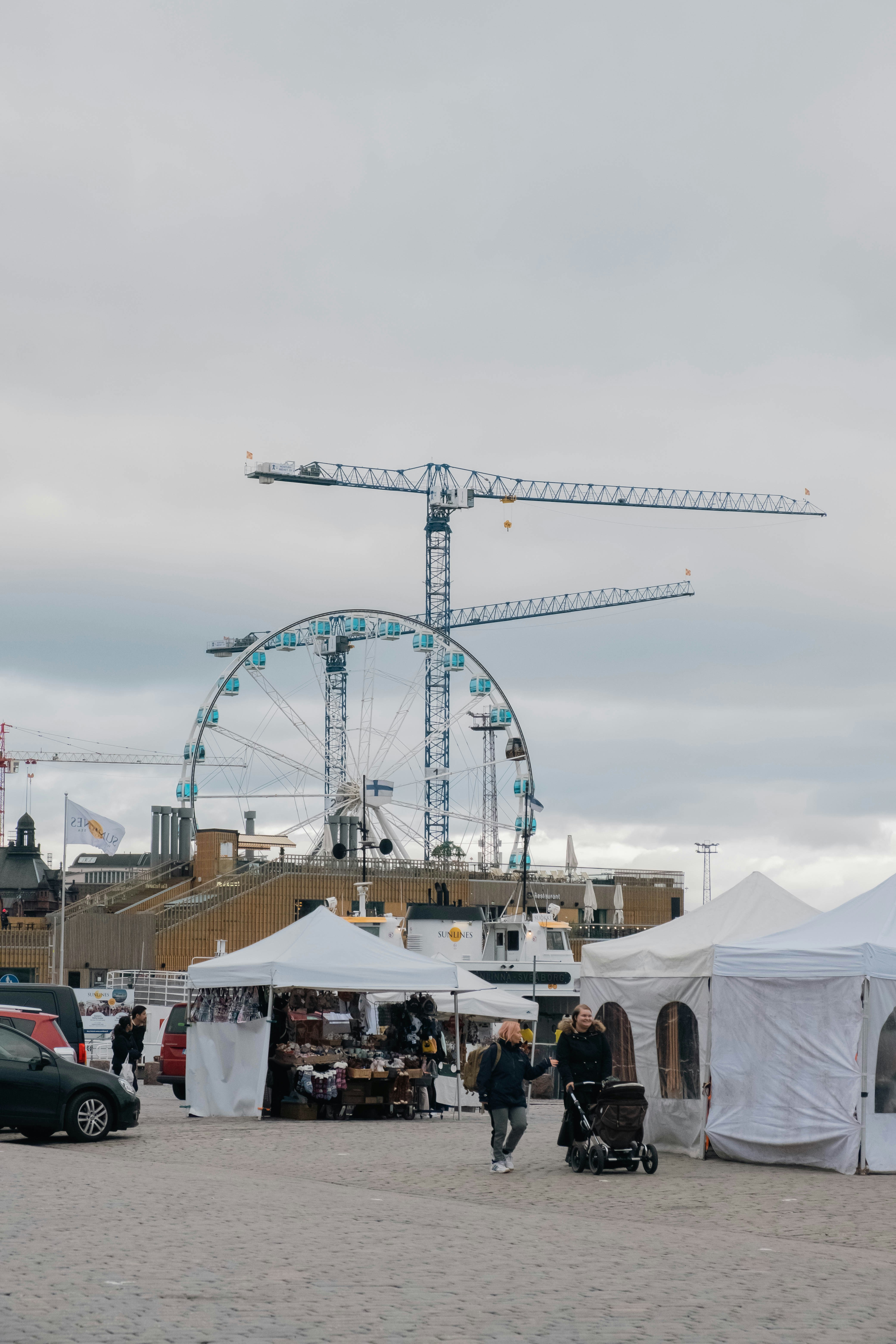 Ferris Wheel at the Waterfront Market under Soft Grey Skies