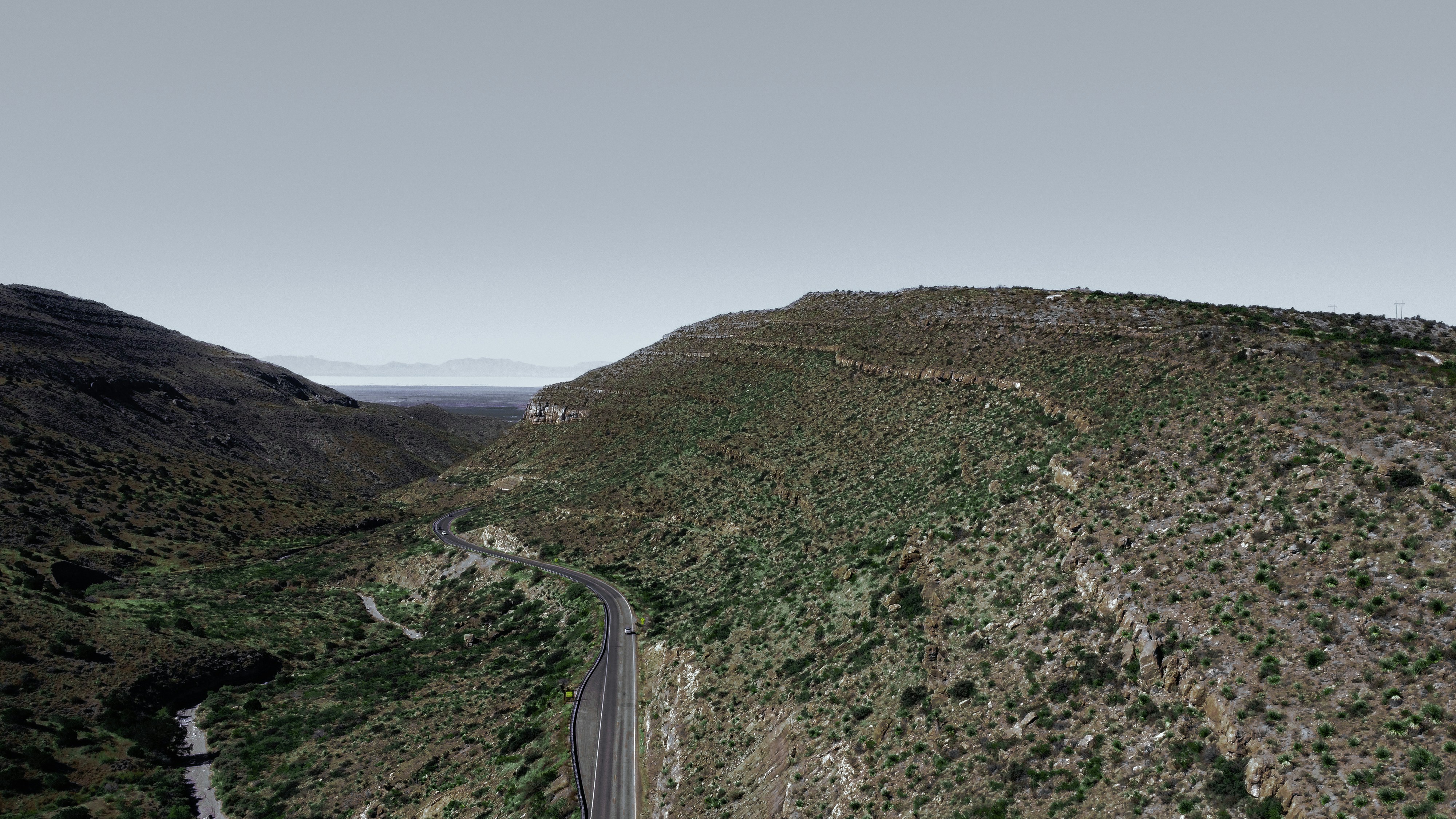 An aerial view of a winding road in the mountains photo – Free Usa ...