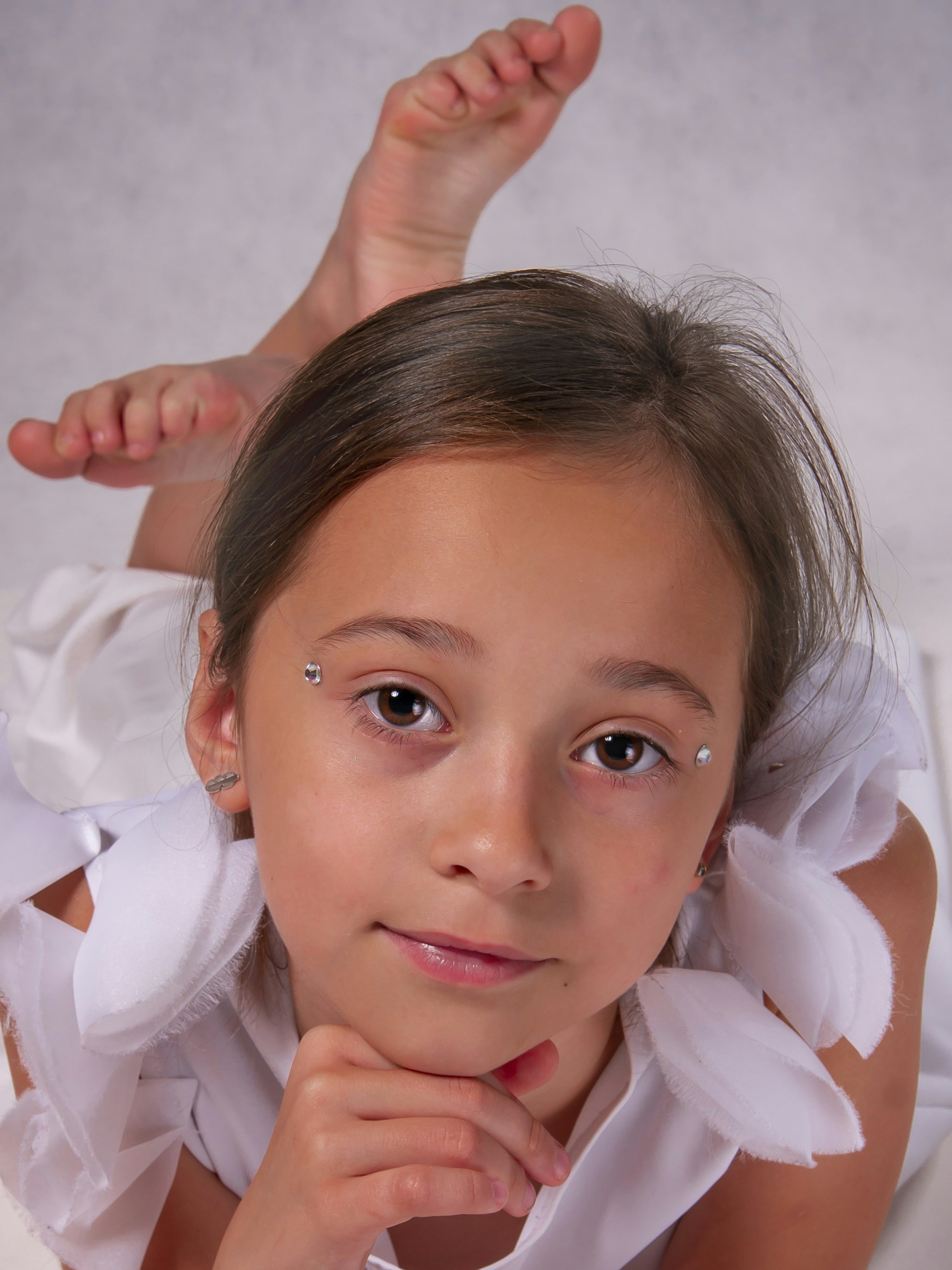 A little girl in a white dress posing for a picture photo – Free Person ...