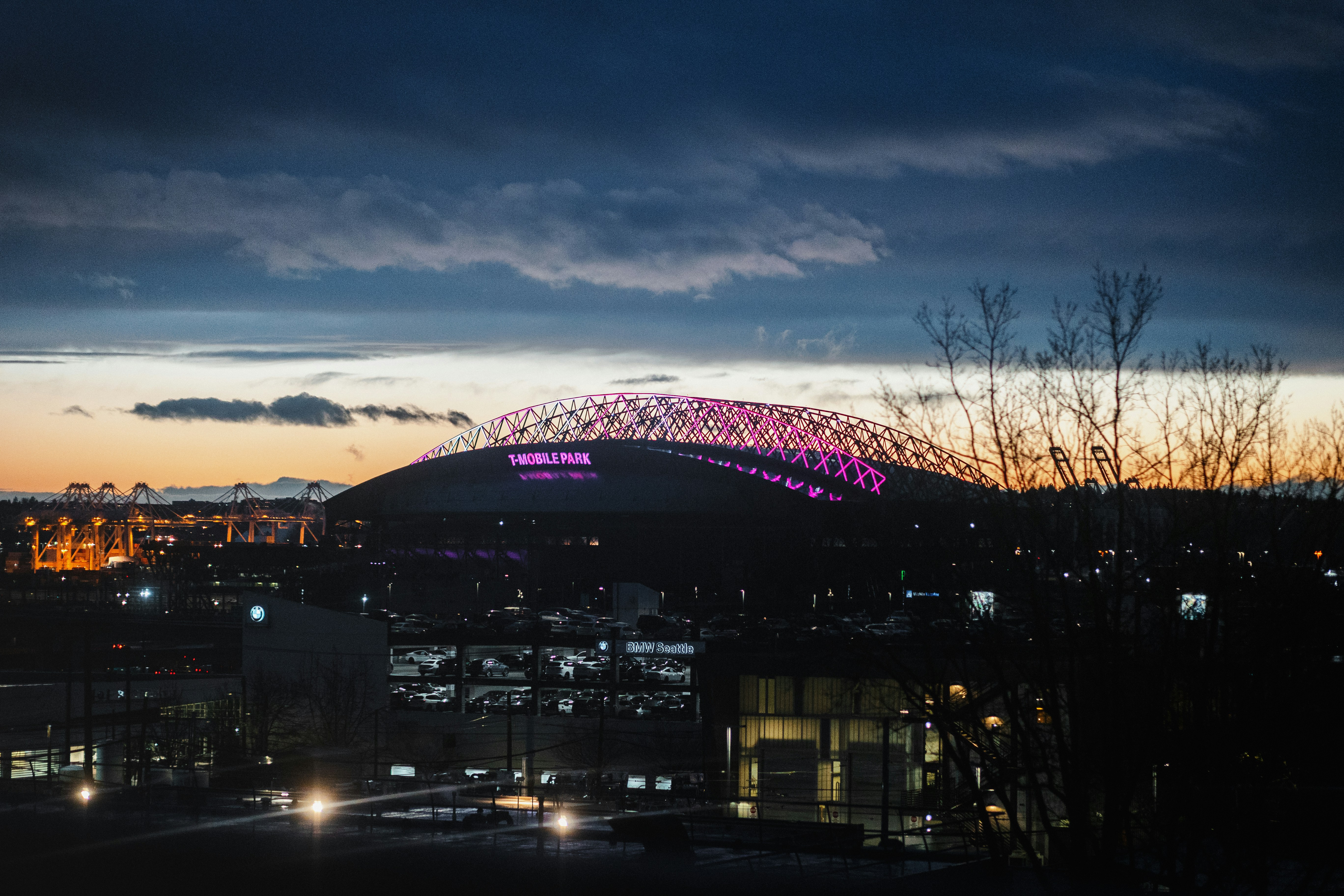 A stadium lit up at night with the lights on photo – Free Arena Image ...