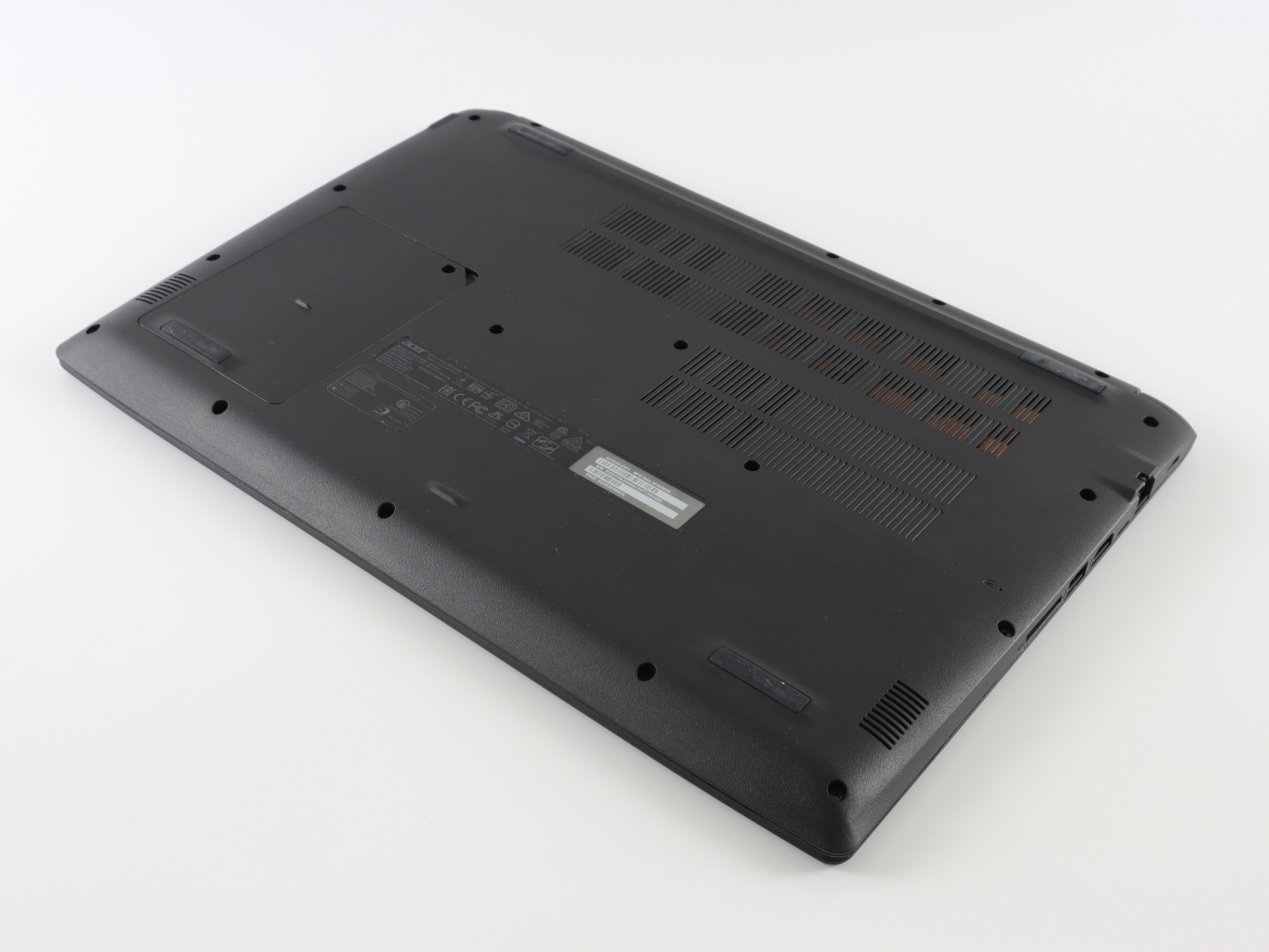 The bottom of a laptop is shown on a white surface photo – Free Acer laptop Image on Unsplash