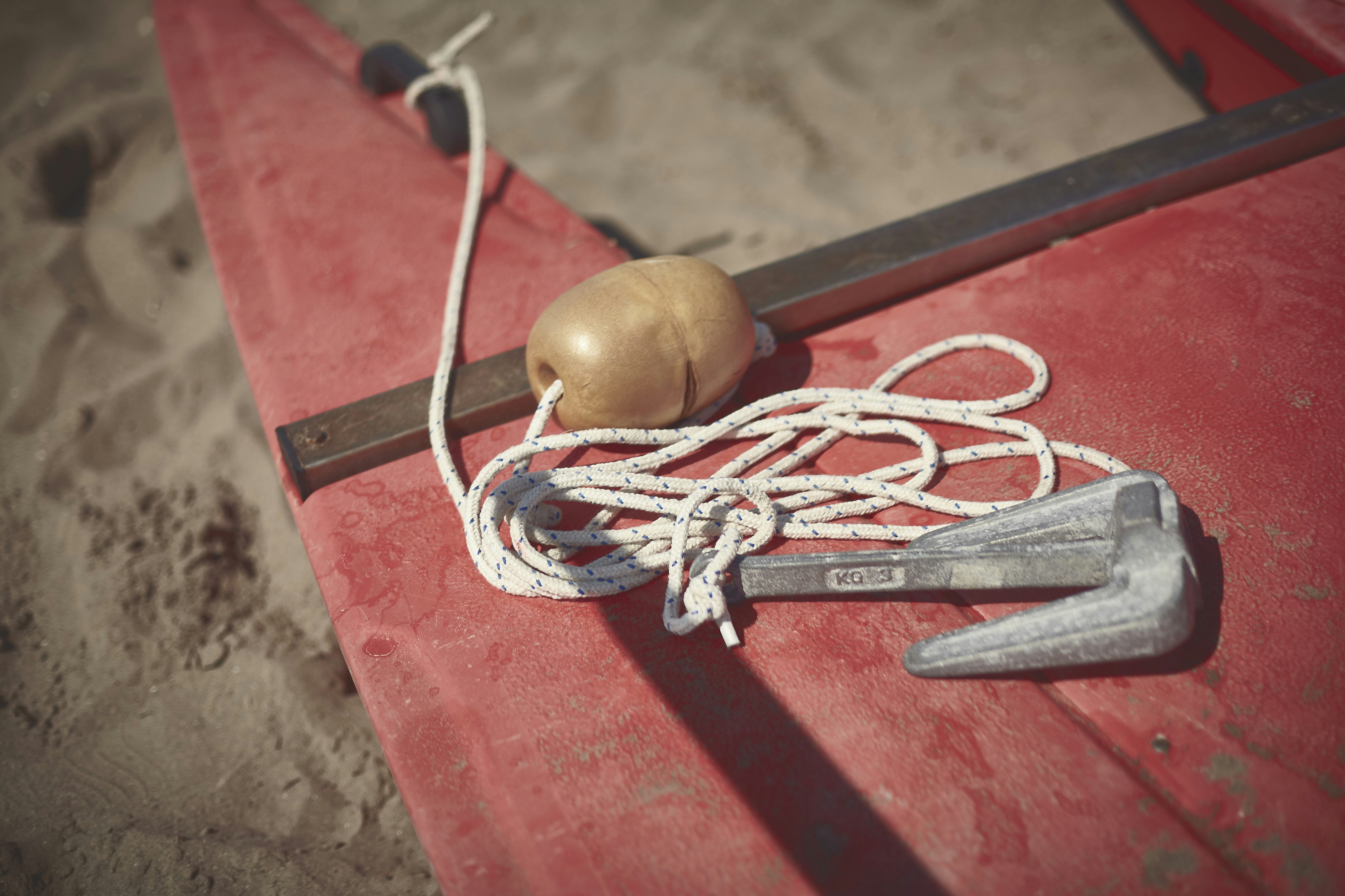 Rope, Tool and Buoy: A Quiet Moment on a Red Boat