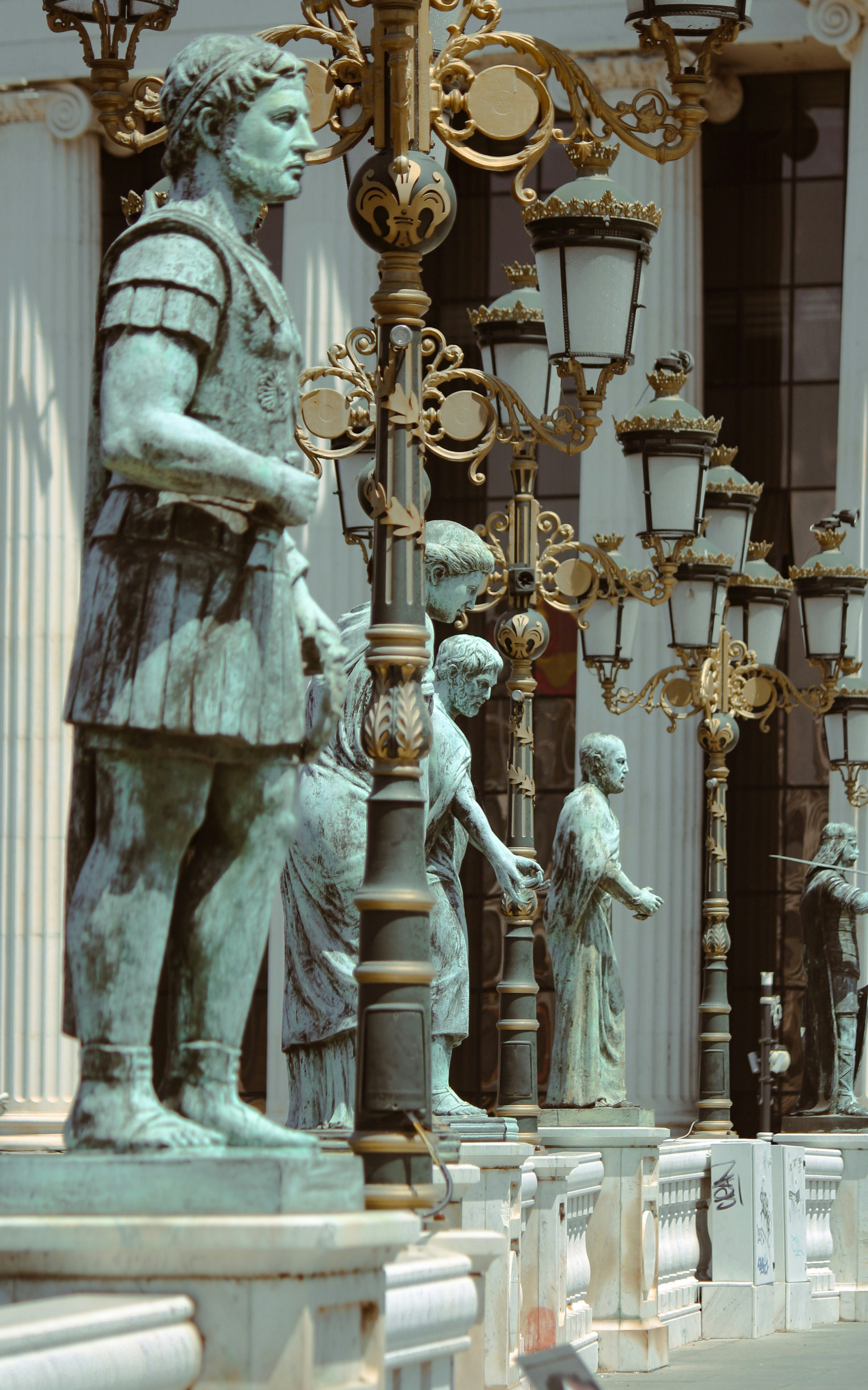 A statue of a man standing next to a lamp post photo – Free Woman Image ...
