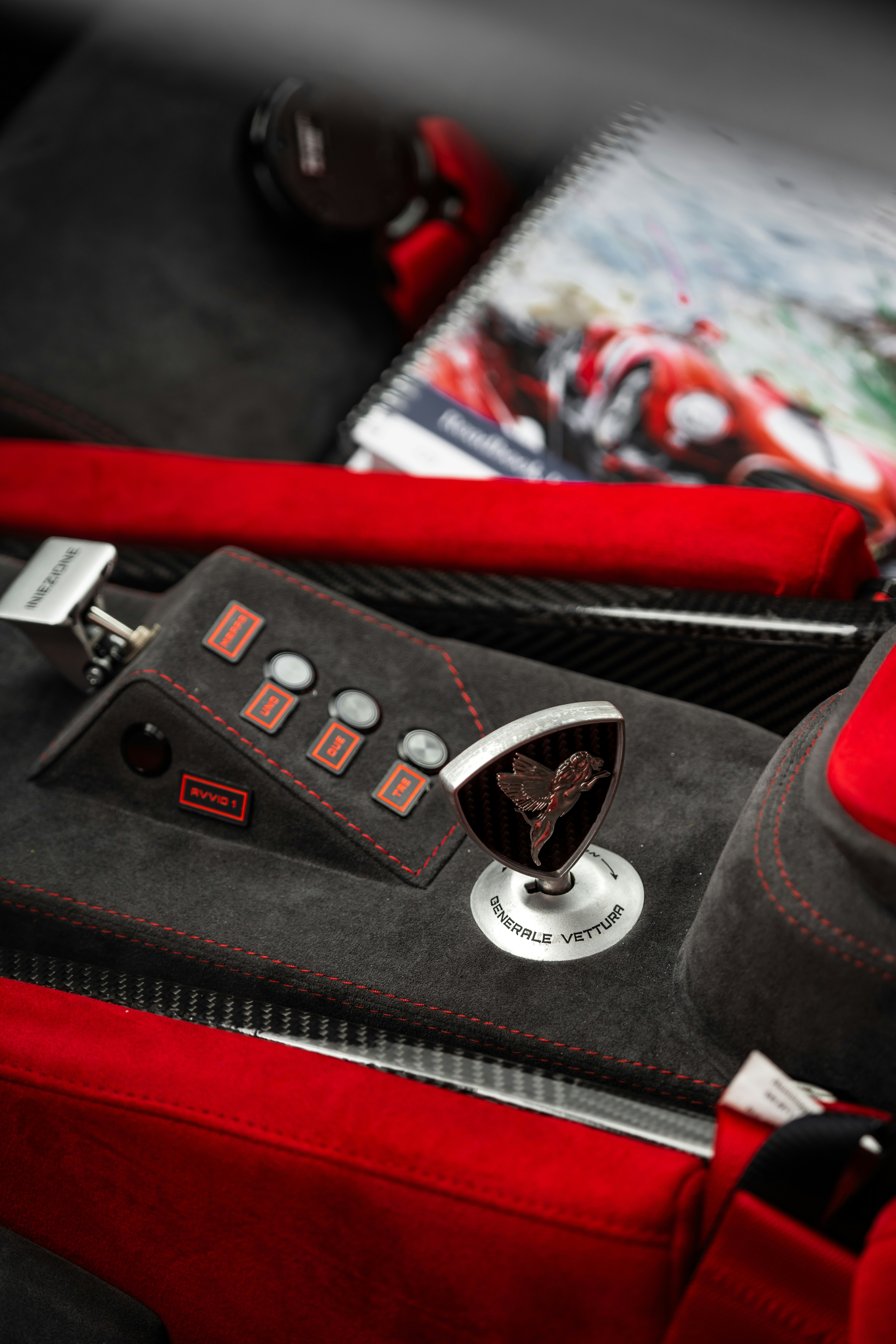 Crimson Console: Crest Emblem Guarding a Racer's Quiet Power