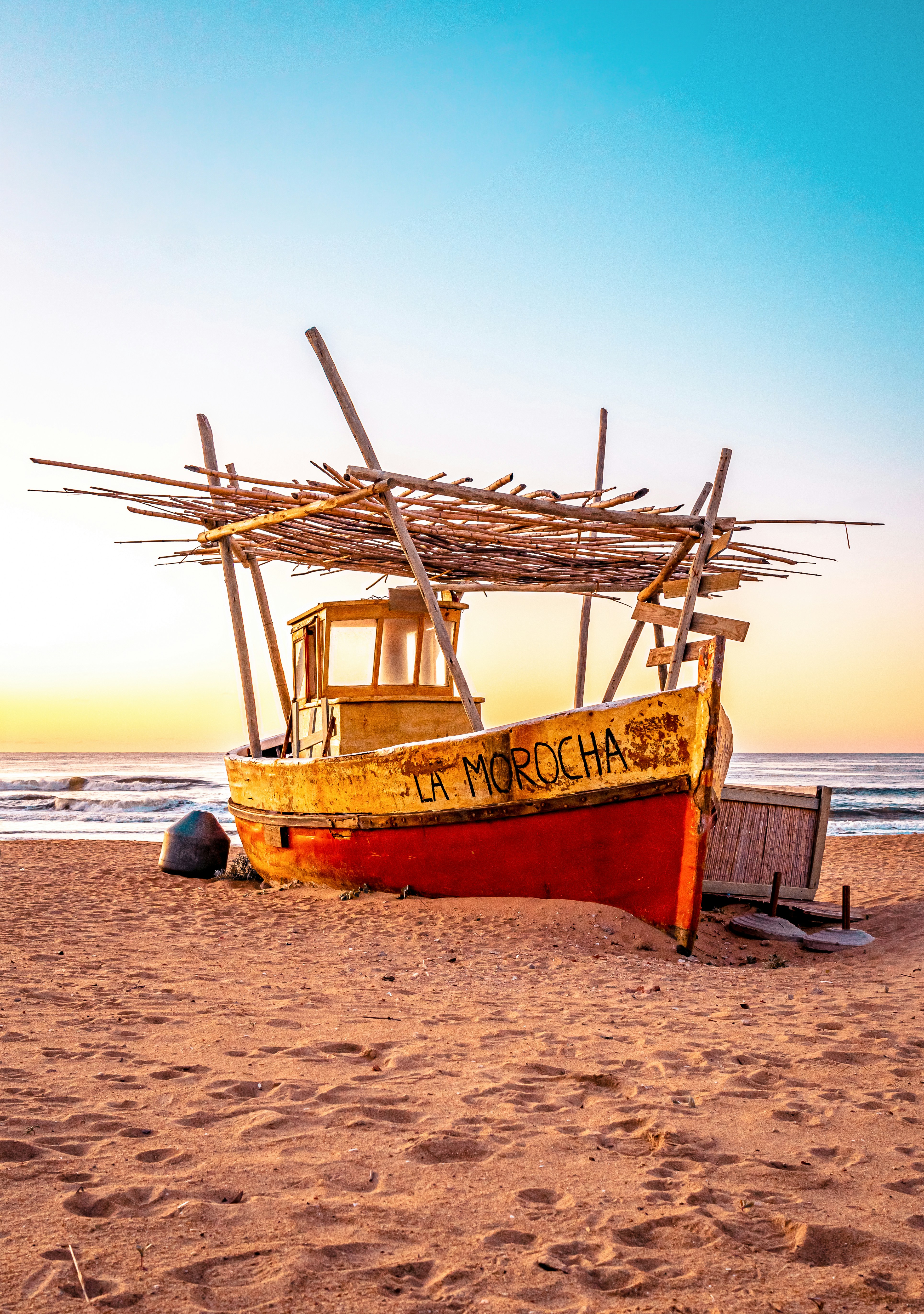 A boat sitting on top of a sandy beach photo – Free Uruguay Image on ...