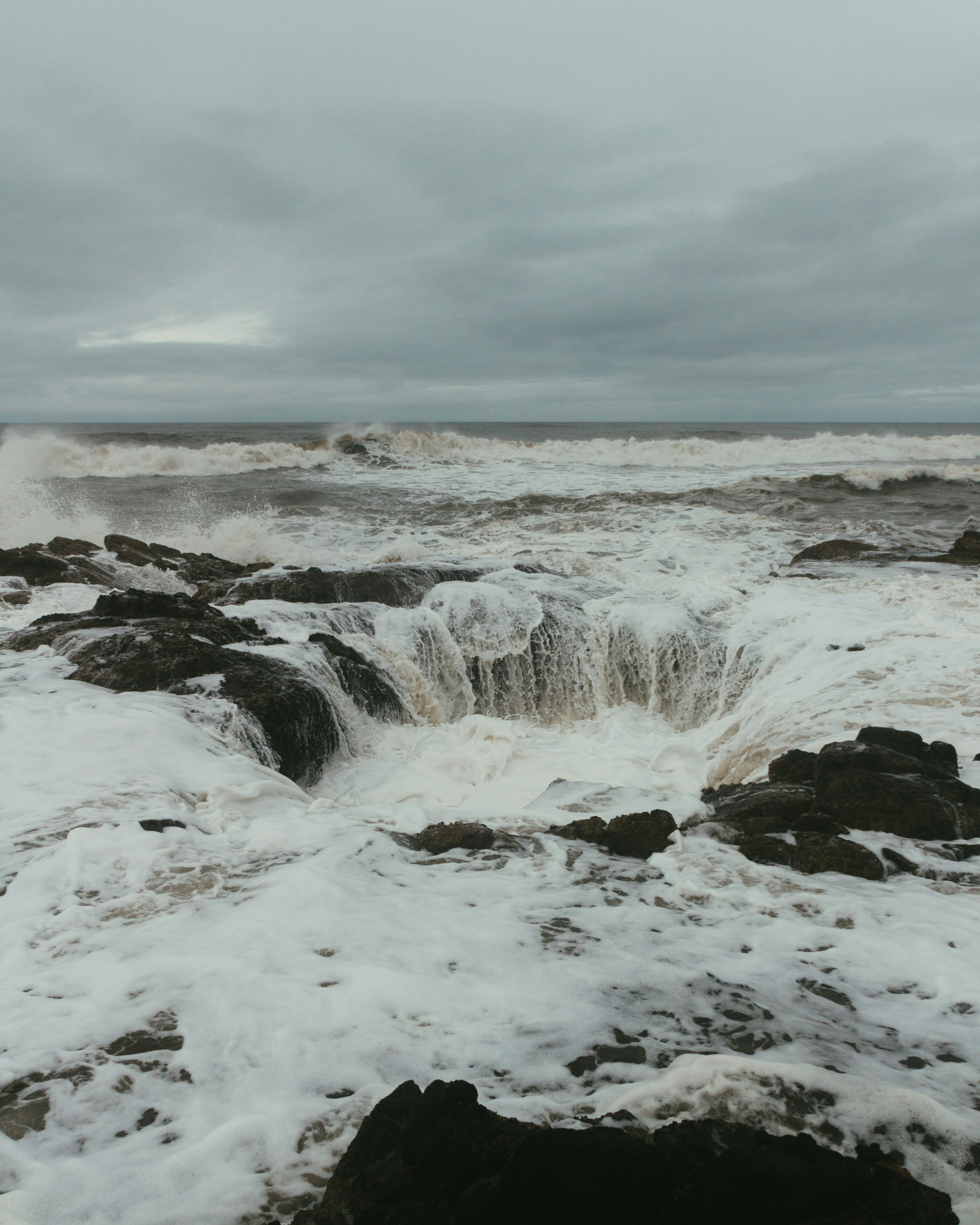 A large body of water surrounded by rocks photo – Free Thor's well ...