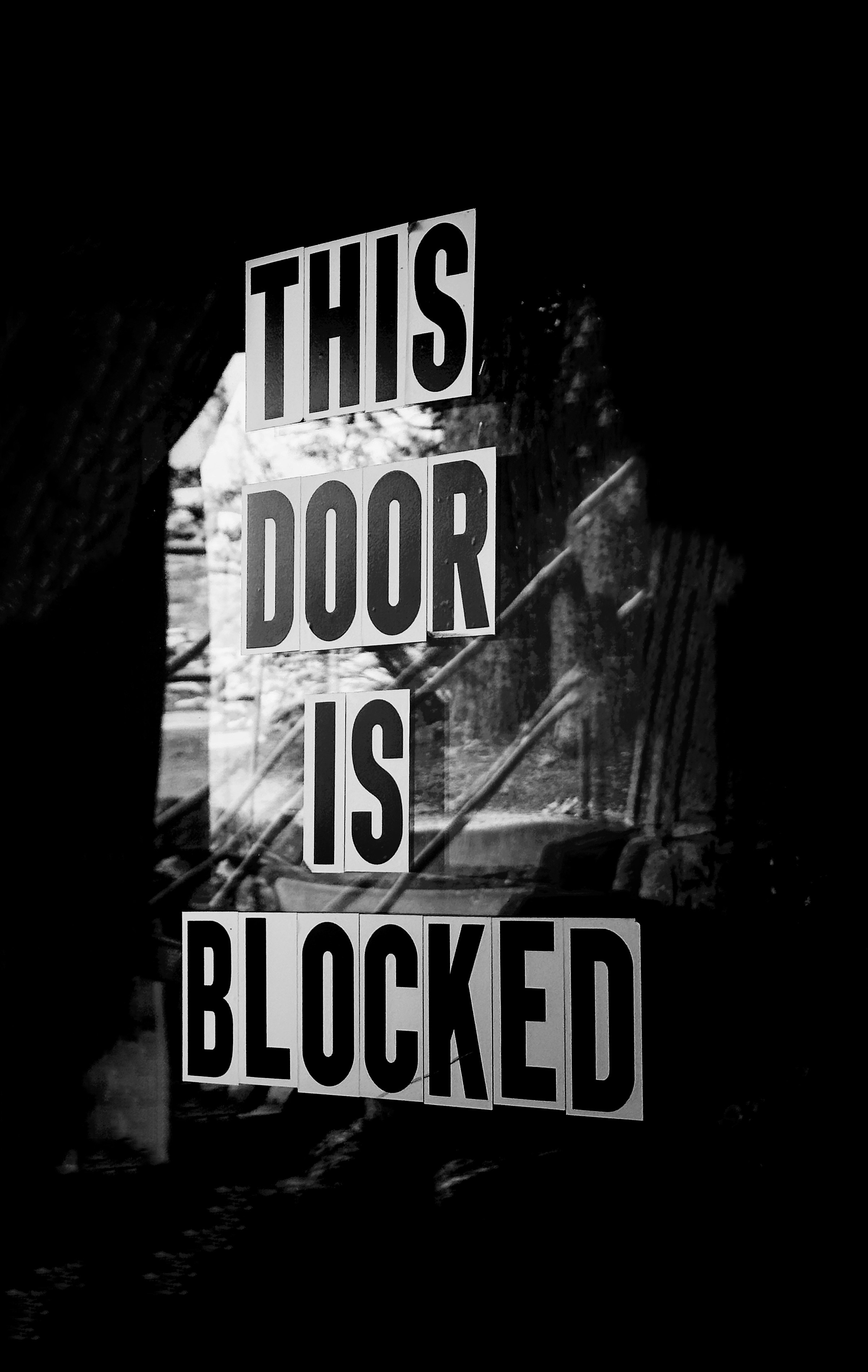 A black and white photo of a sign that says this door is blocked photo ...