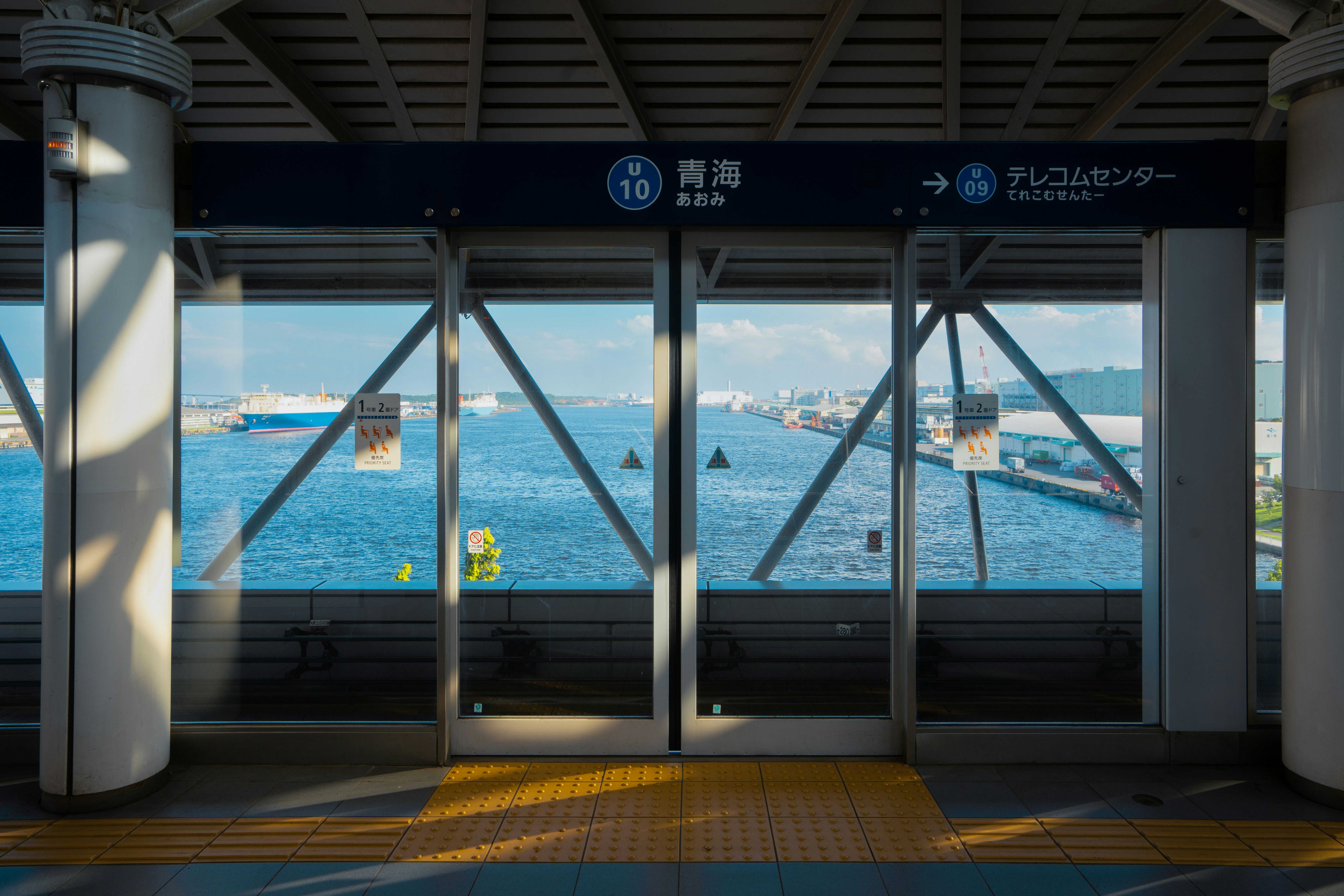 Sunlit Harbor Framed by Station Glass Doors on a Seaside Platform