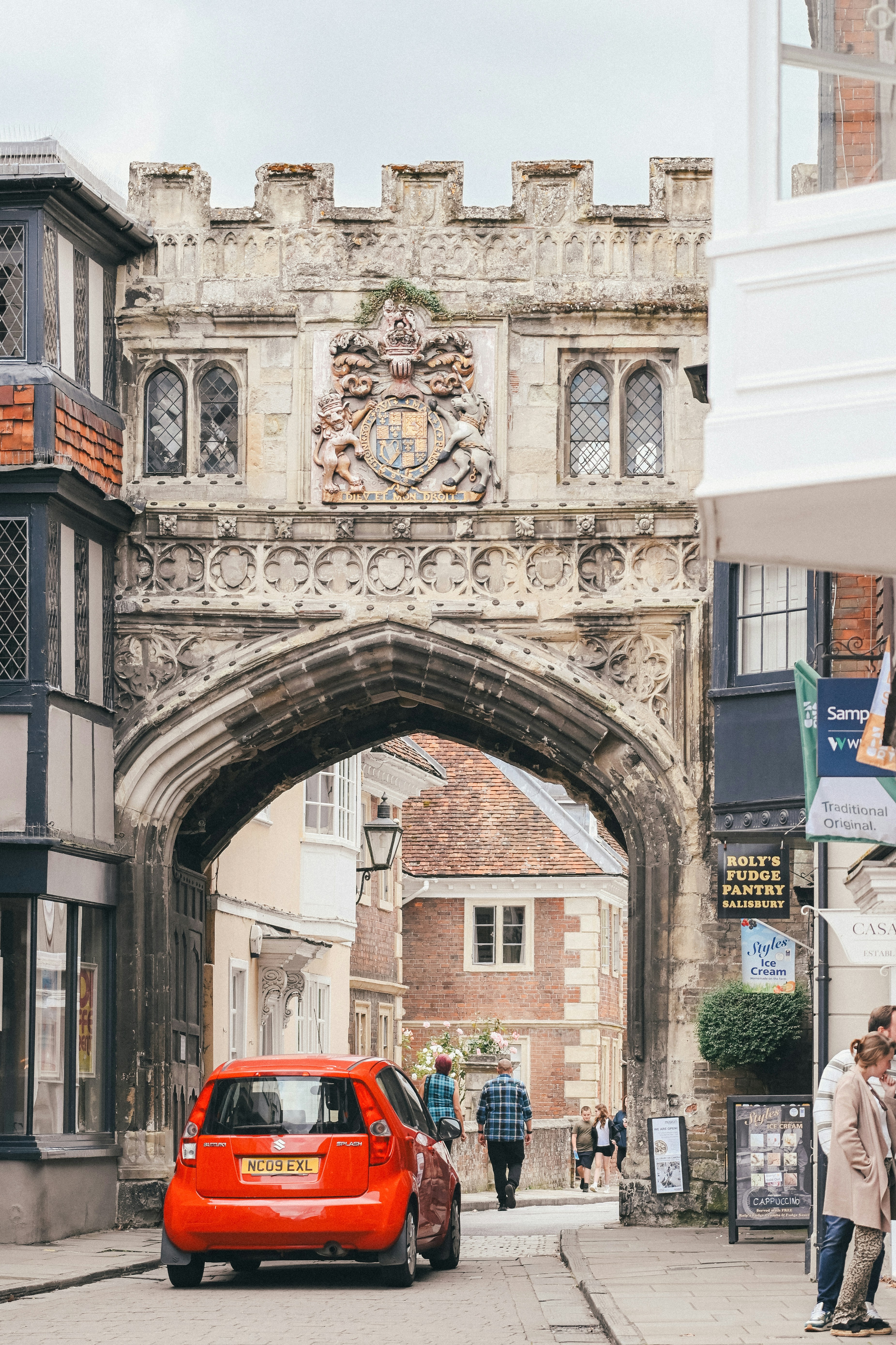 Medieval Archway Over a Quiet Market Street with a Red Car