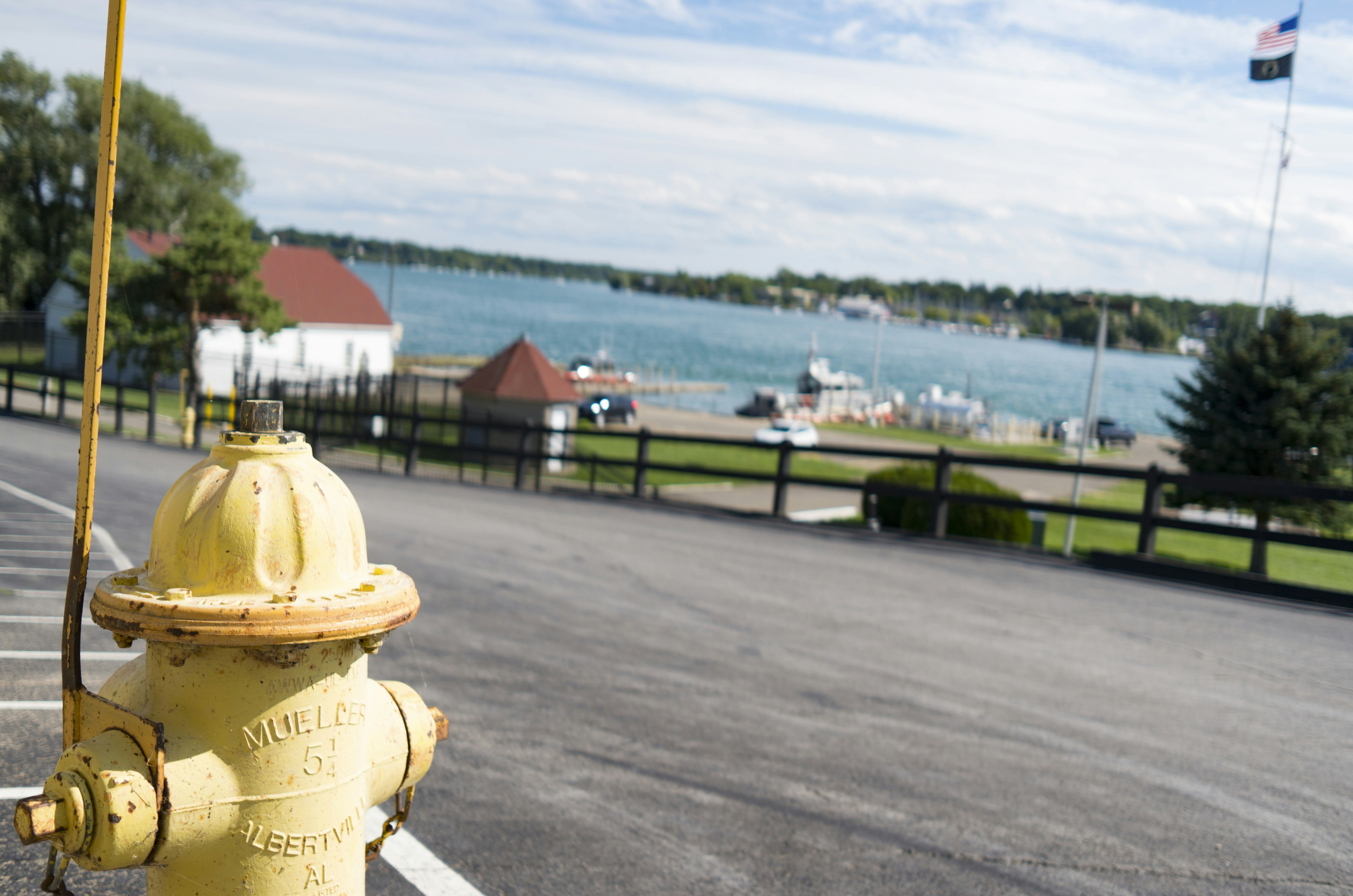 Canary Fire Hydrant Framing a Quiet Harbor Scene
