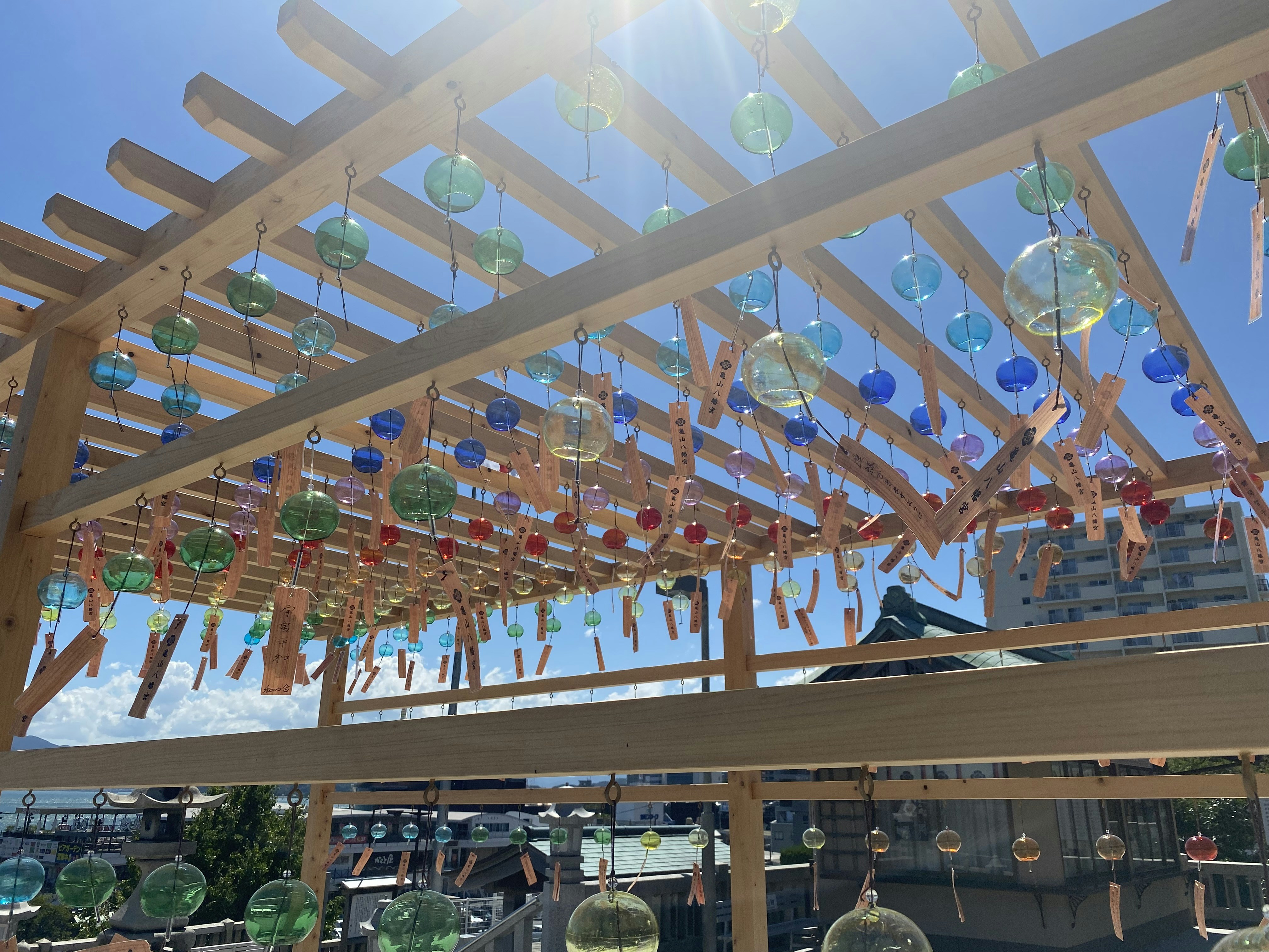 A wooden structure with glass balls hanging from it photo – Free 日本 ...