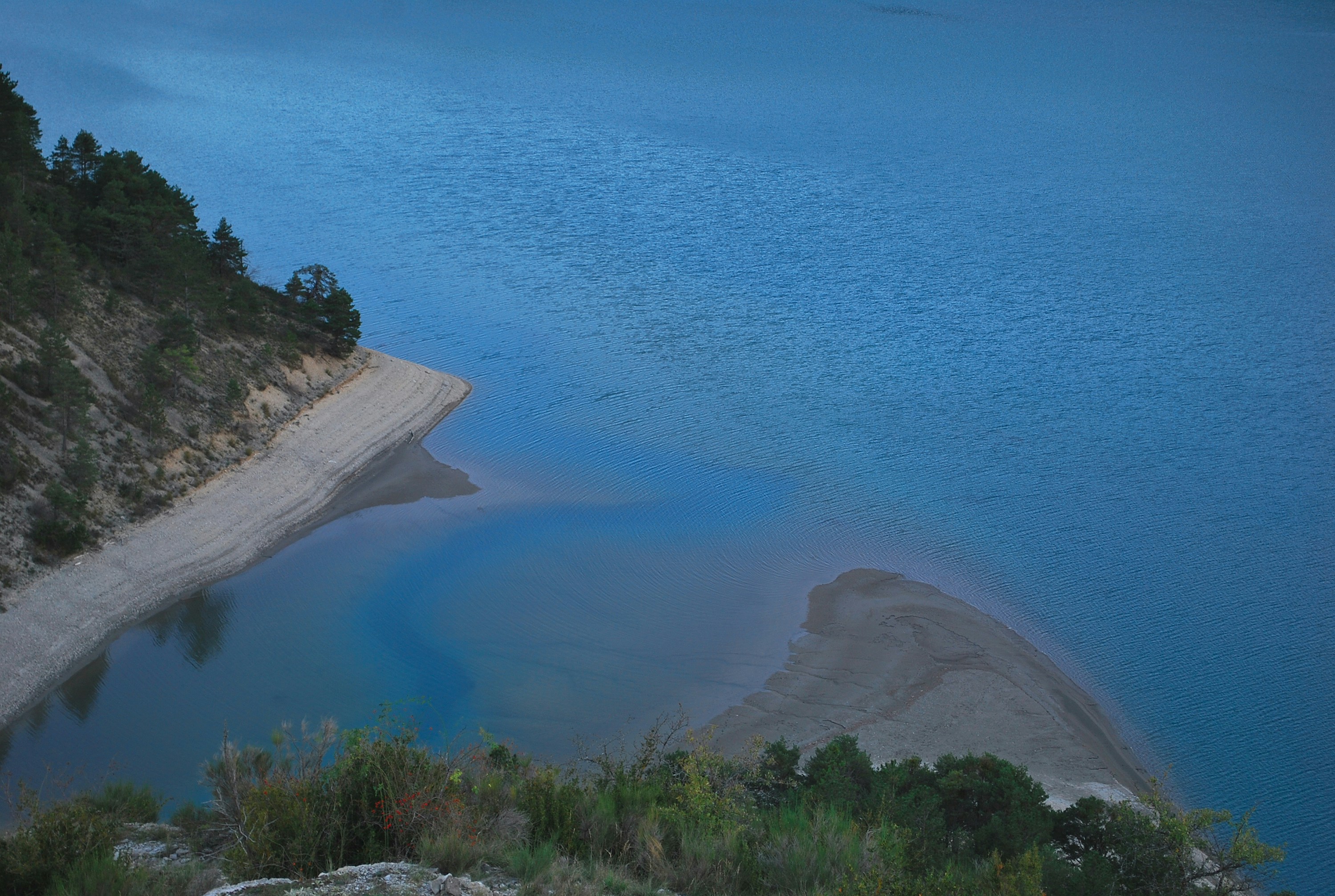 Turquoise Crescent Inlet Framed by Pine-Clad Cliffs
