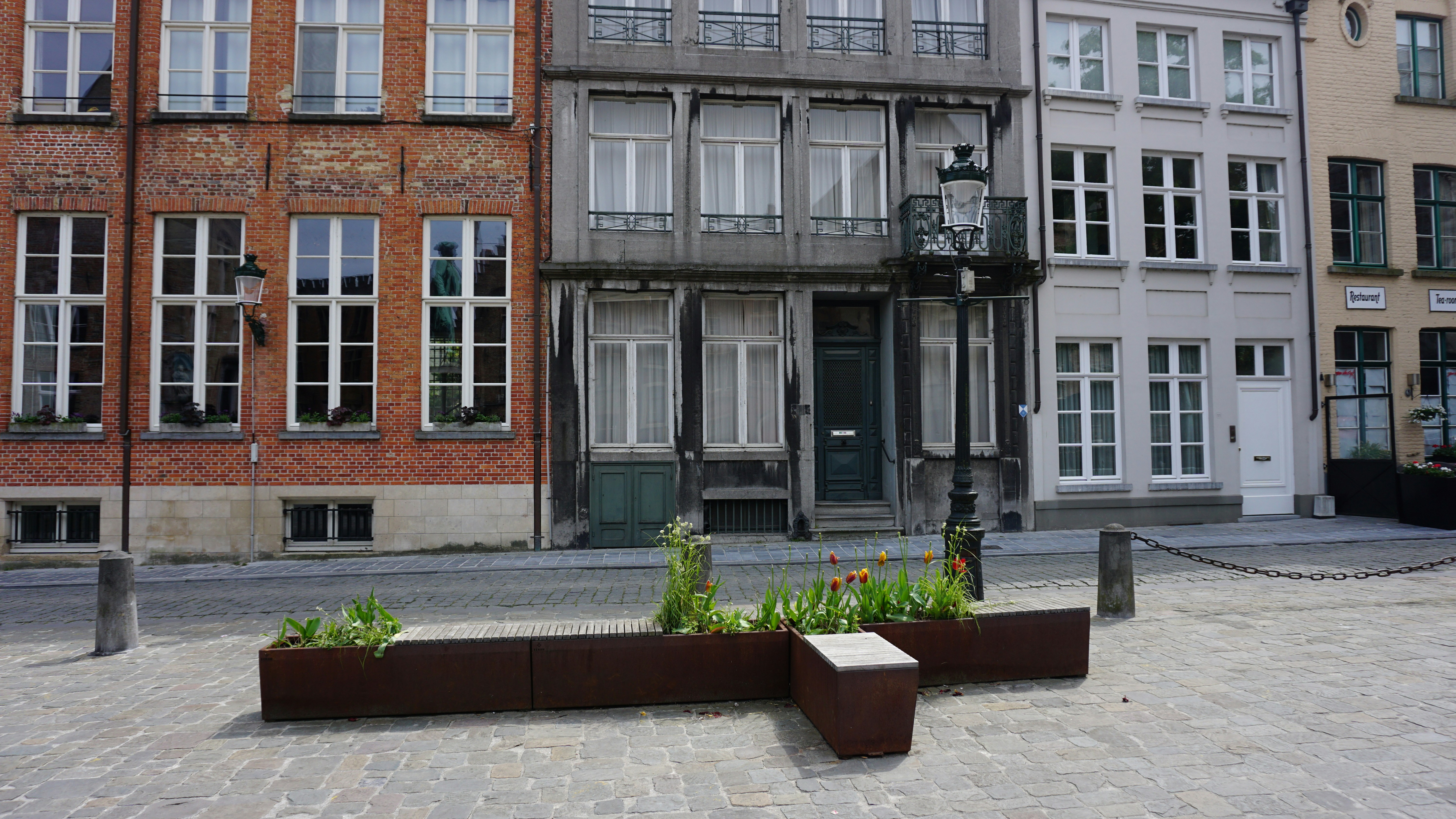 Contemporary planter and historic building facades in a quiet street.