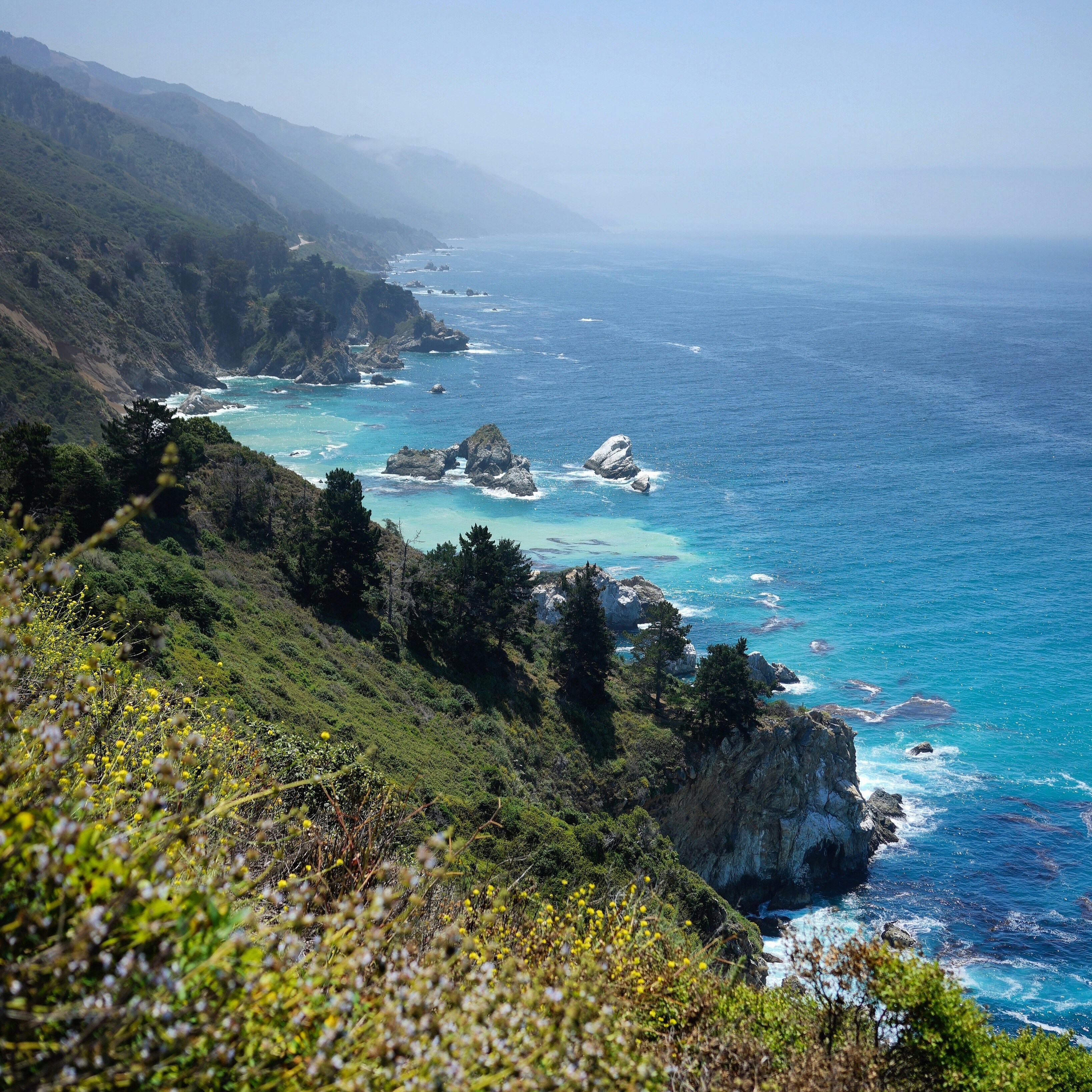 Vibrant coastline with rugged cliffs and turquoise waters, capturing the harmonious blend of nature's elements.