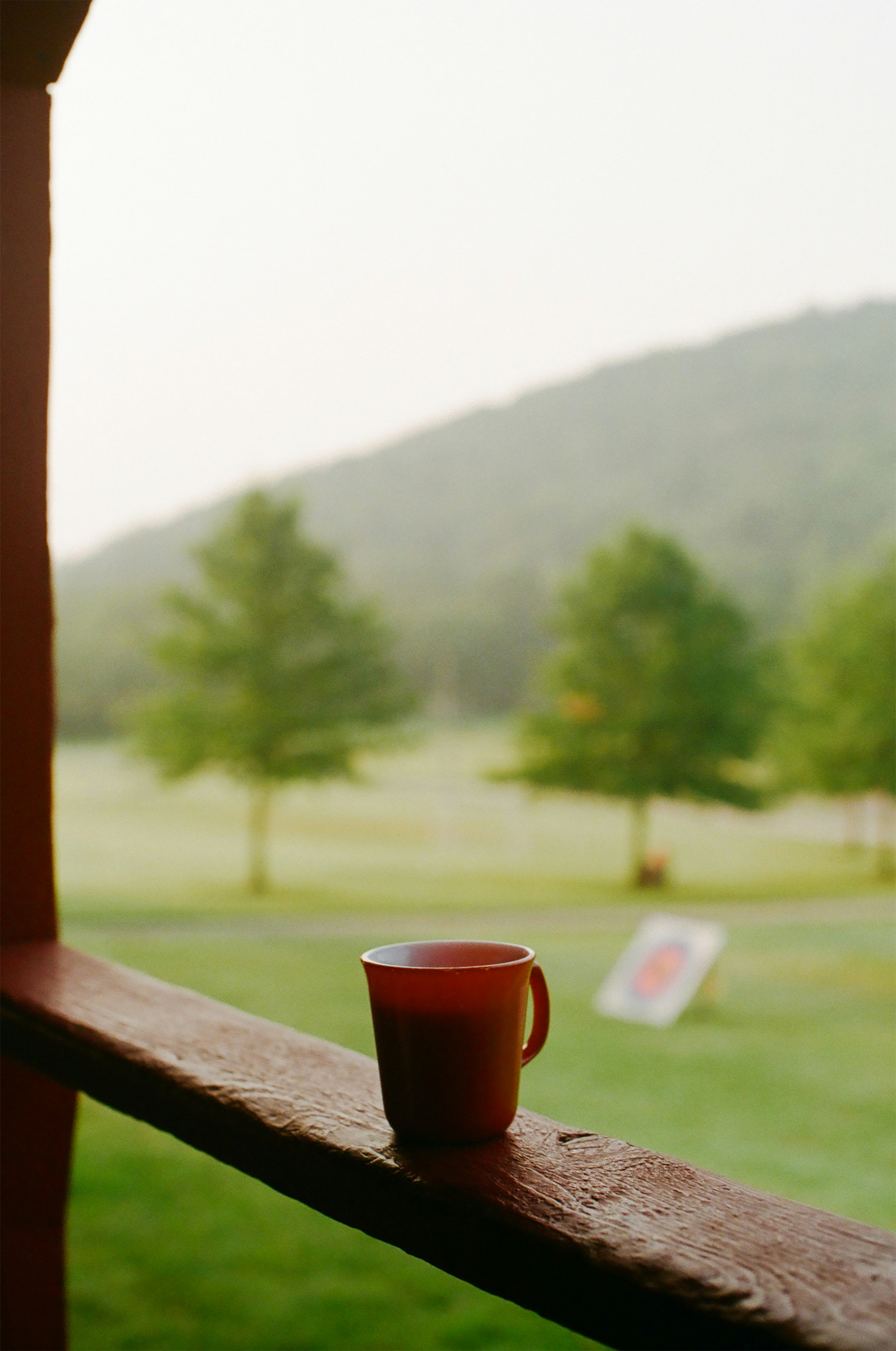 A cup of coffee sitting on a wooden ledge photo – Free #camp Image on ...