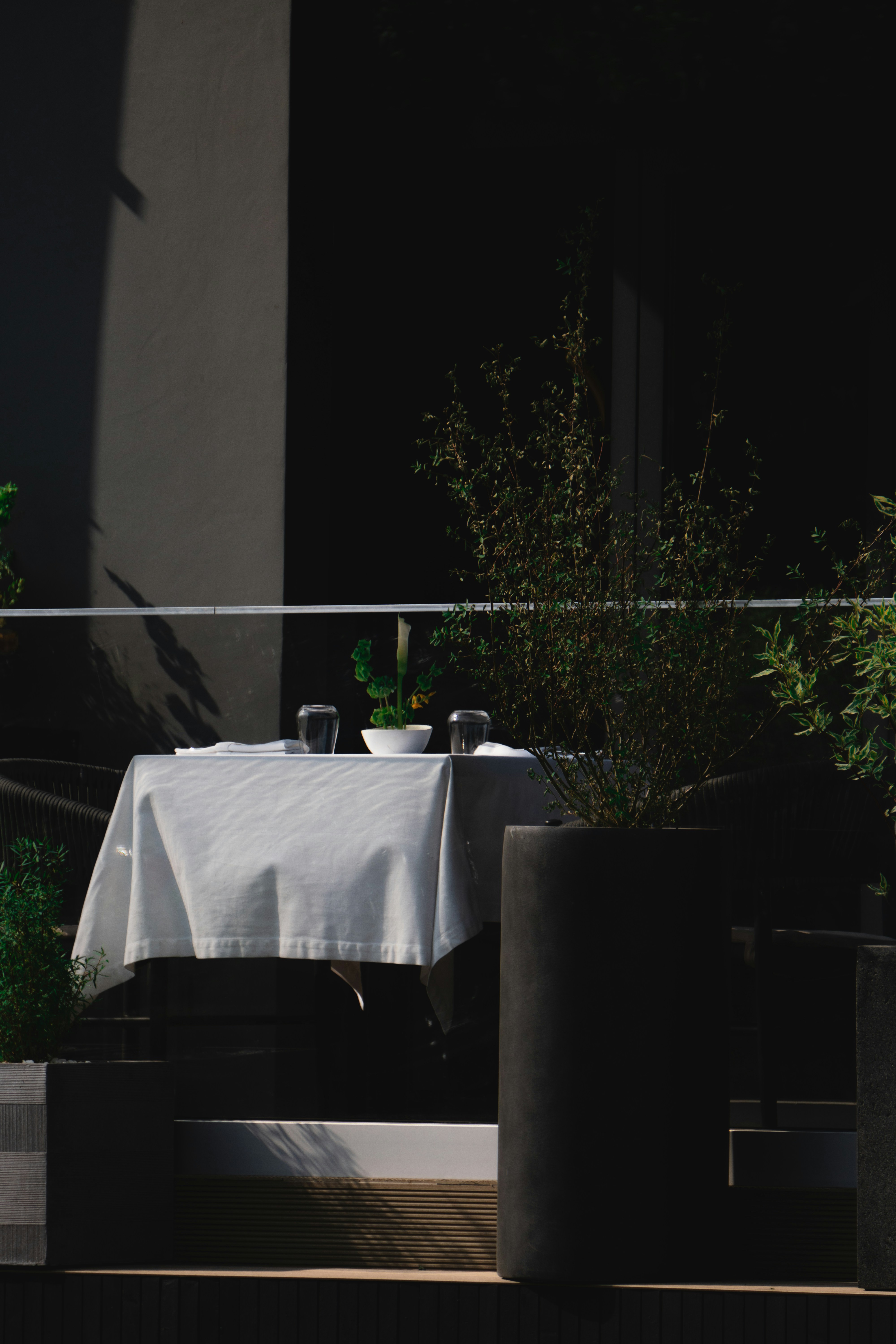 Moonlit Terrace Table with White Linen on a Shadowed Deck