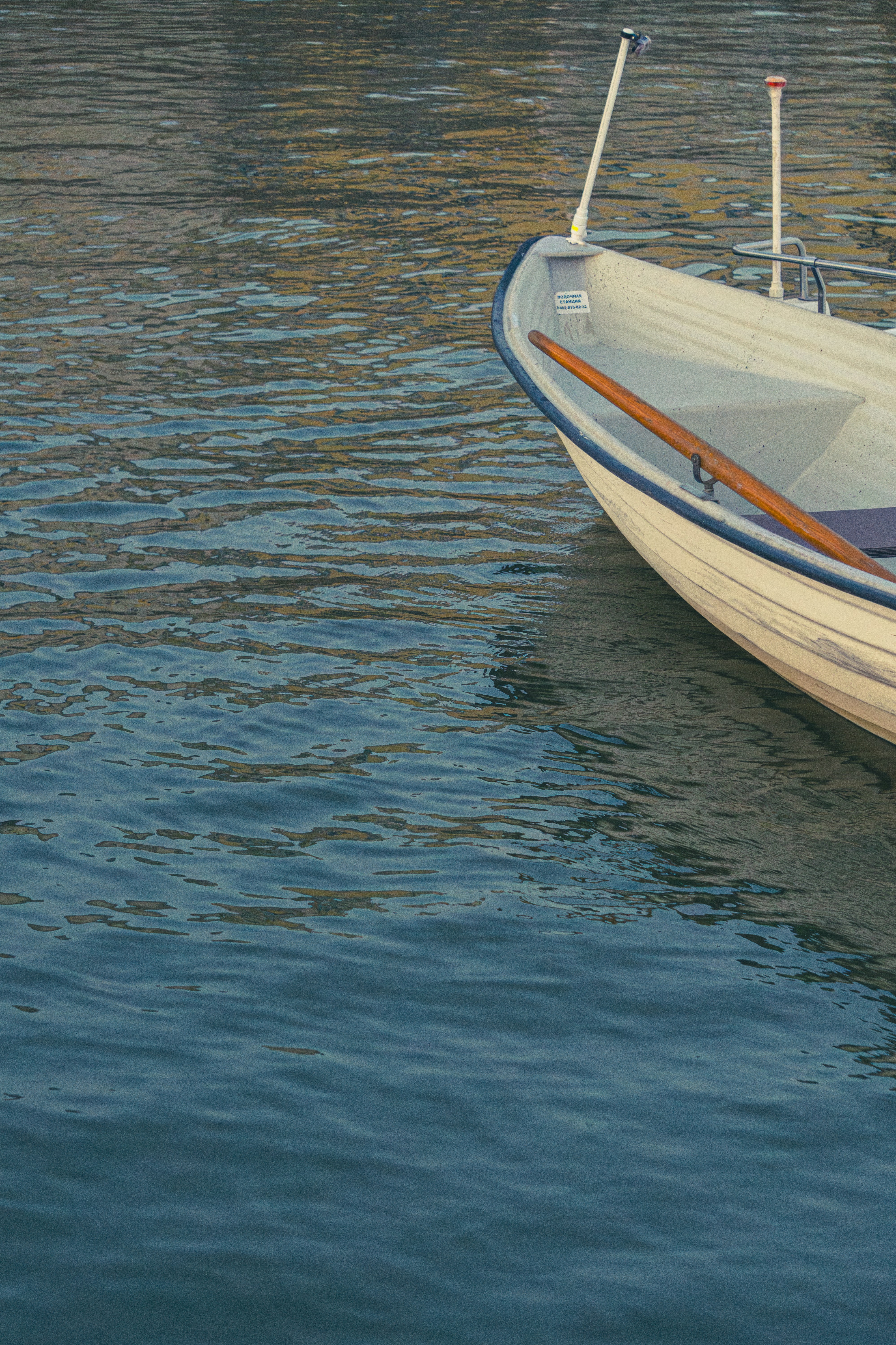 Bow on Blue: A Quiet Rowboat Anchored at the Edge of the Frame