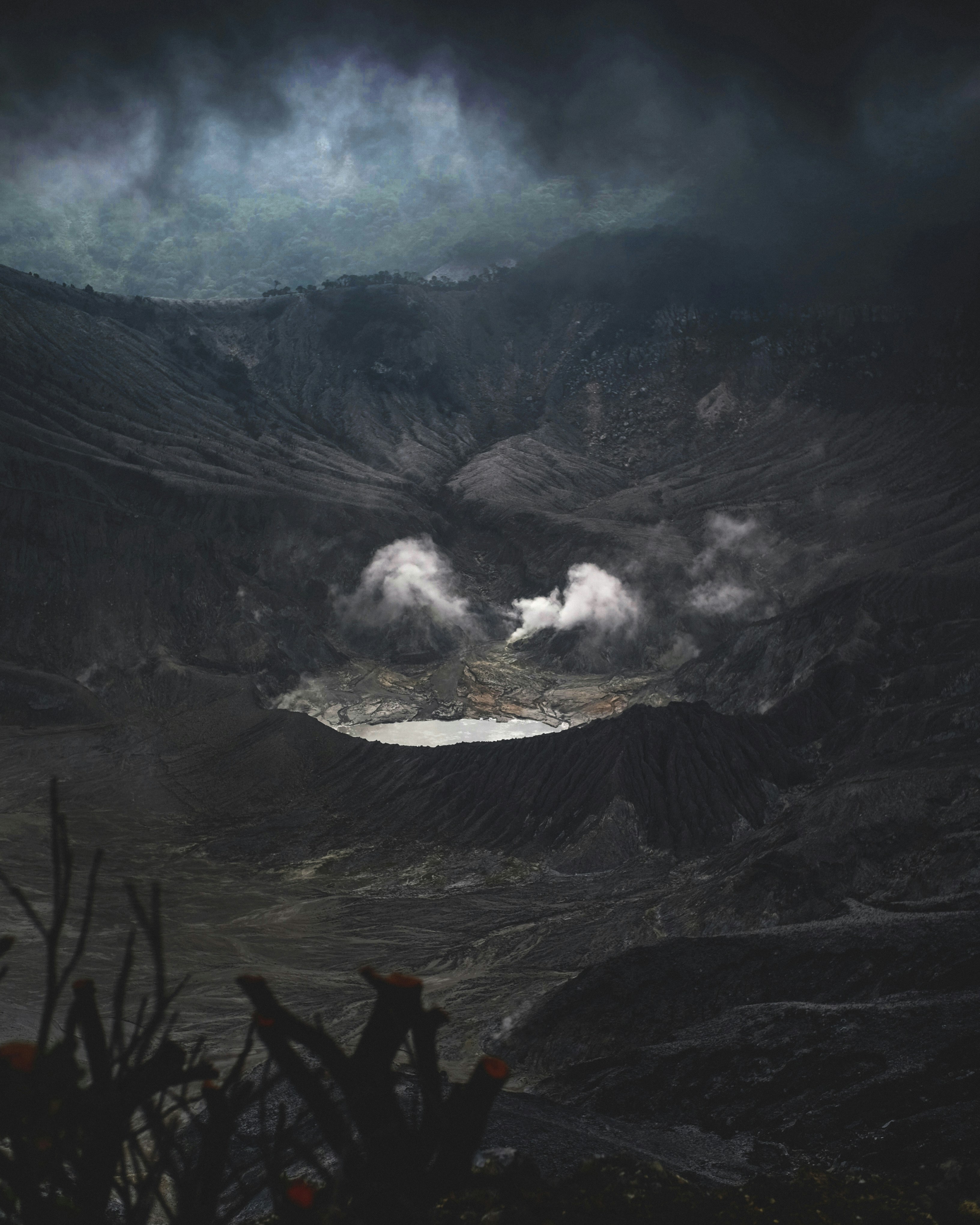 A view of a mountain with a lake in the middle of it photo – Free ...