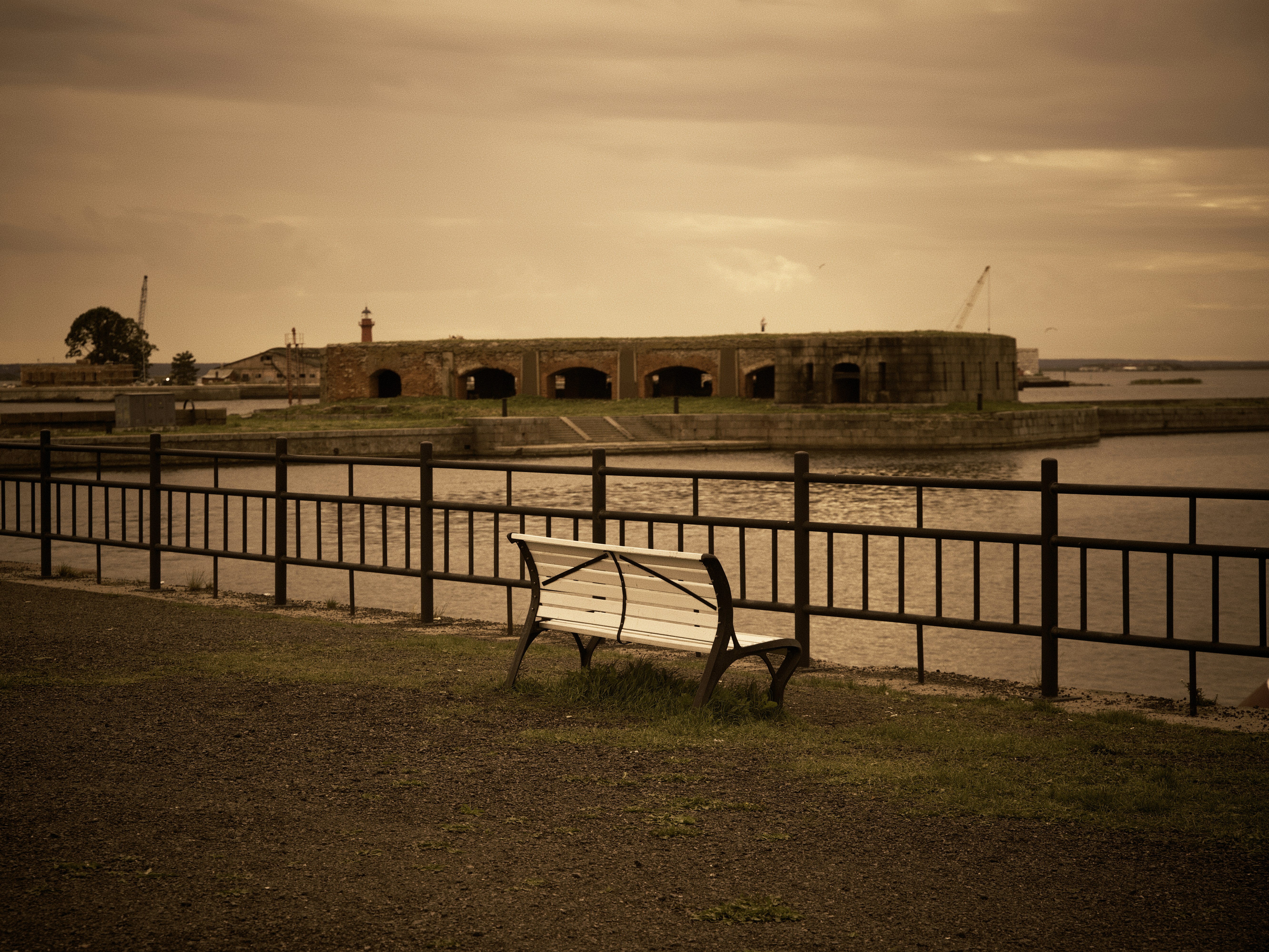 Harbor Seat at Dusk: A Weathered Bench Overlooking the Quiet Fort