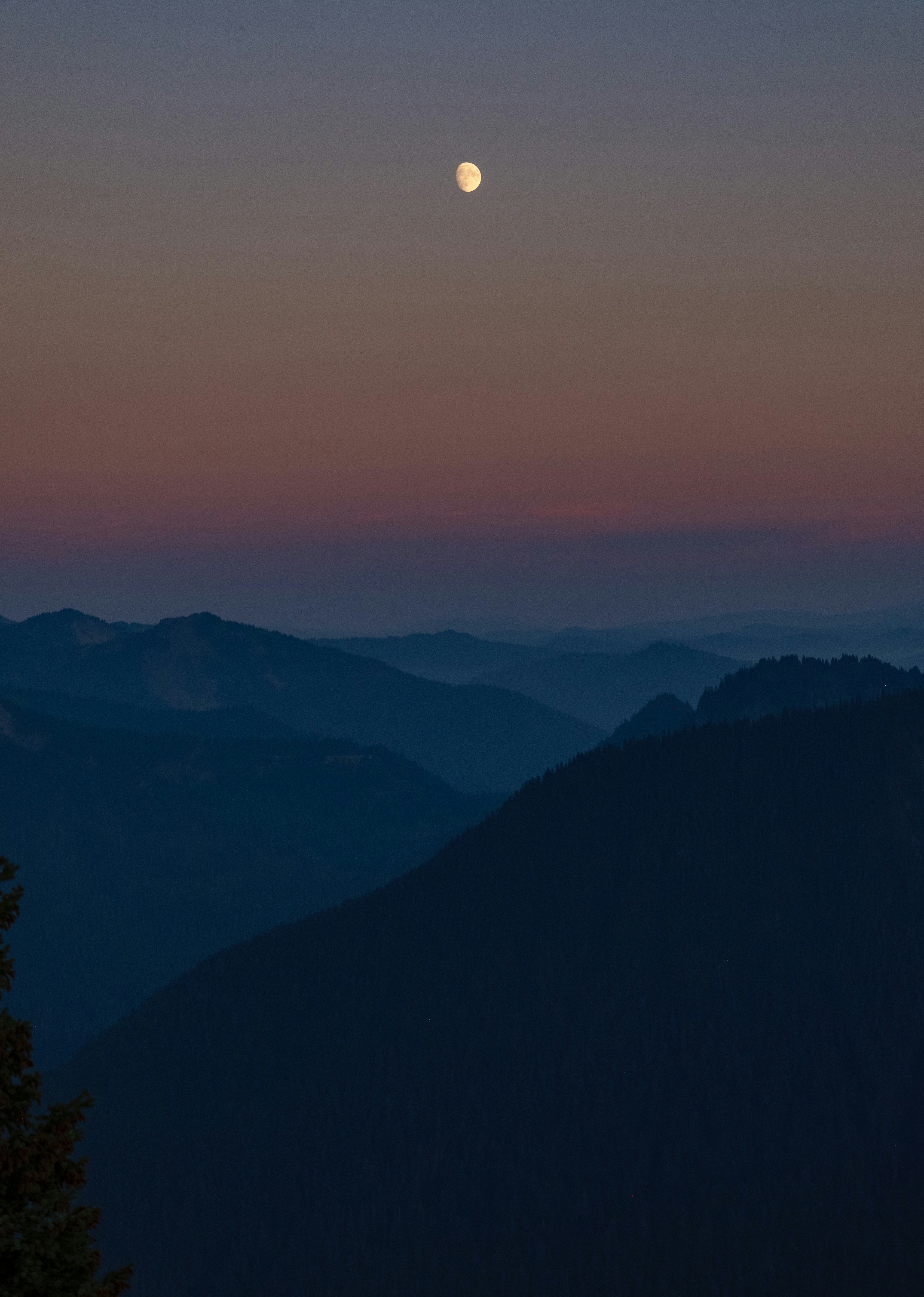 A full moon is seen over a mountain range photo – Free Sunset Image on ...