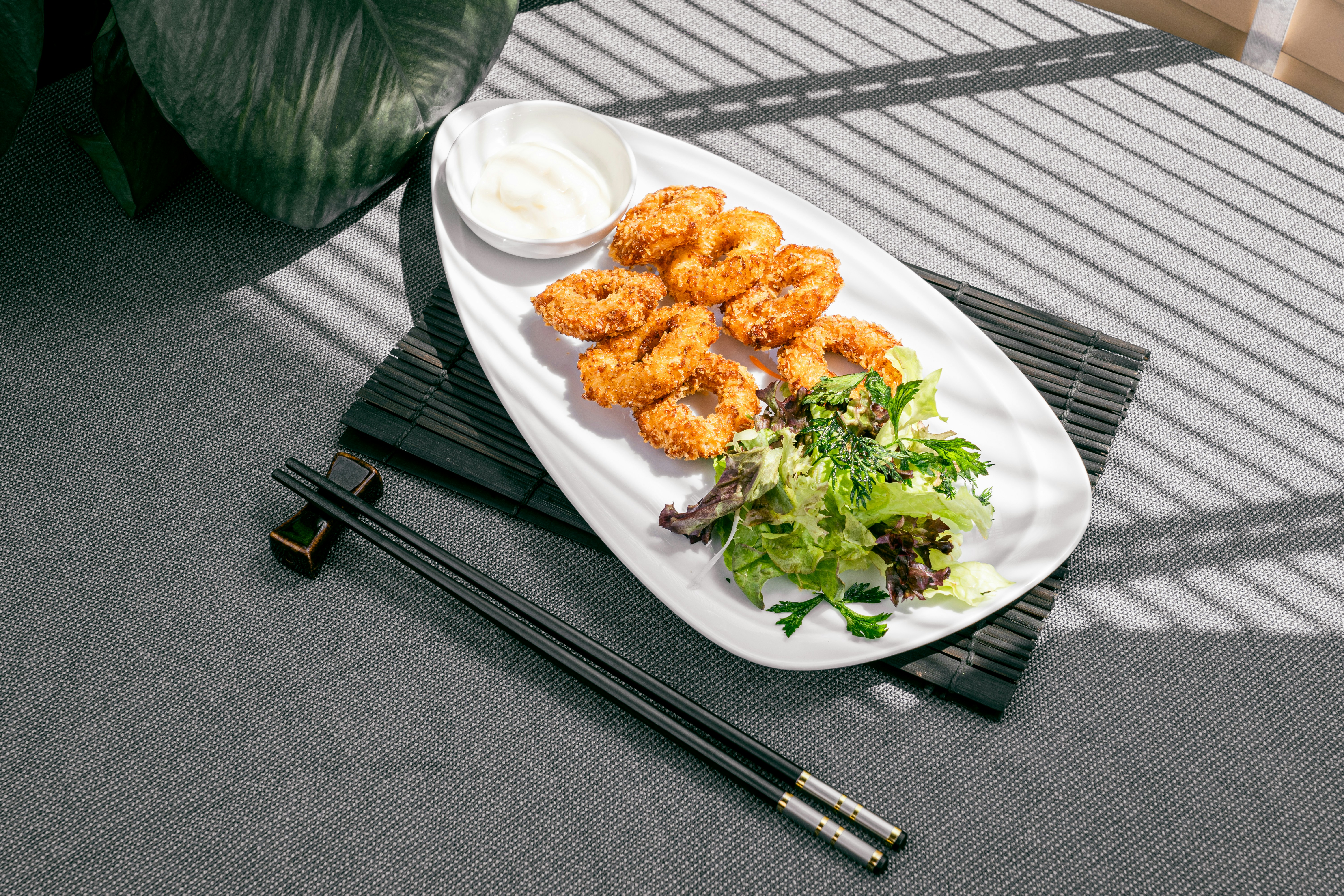 A plate of food on a table with chopsticks photo – Free Food ...
