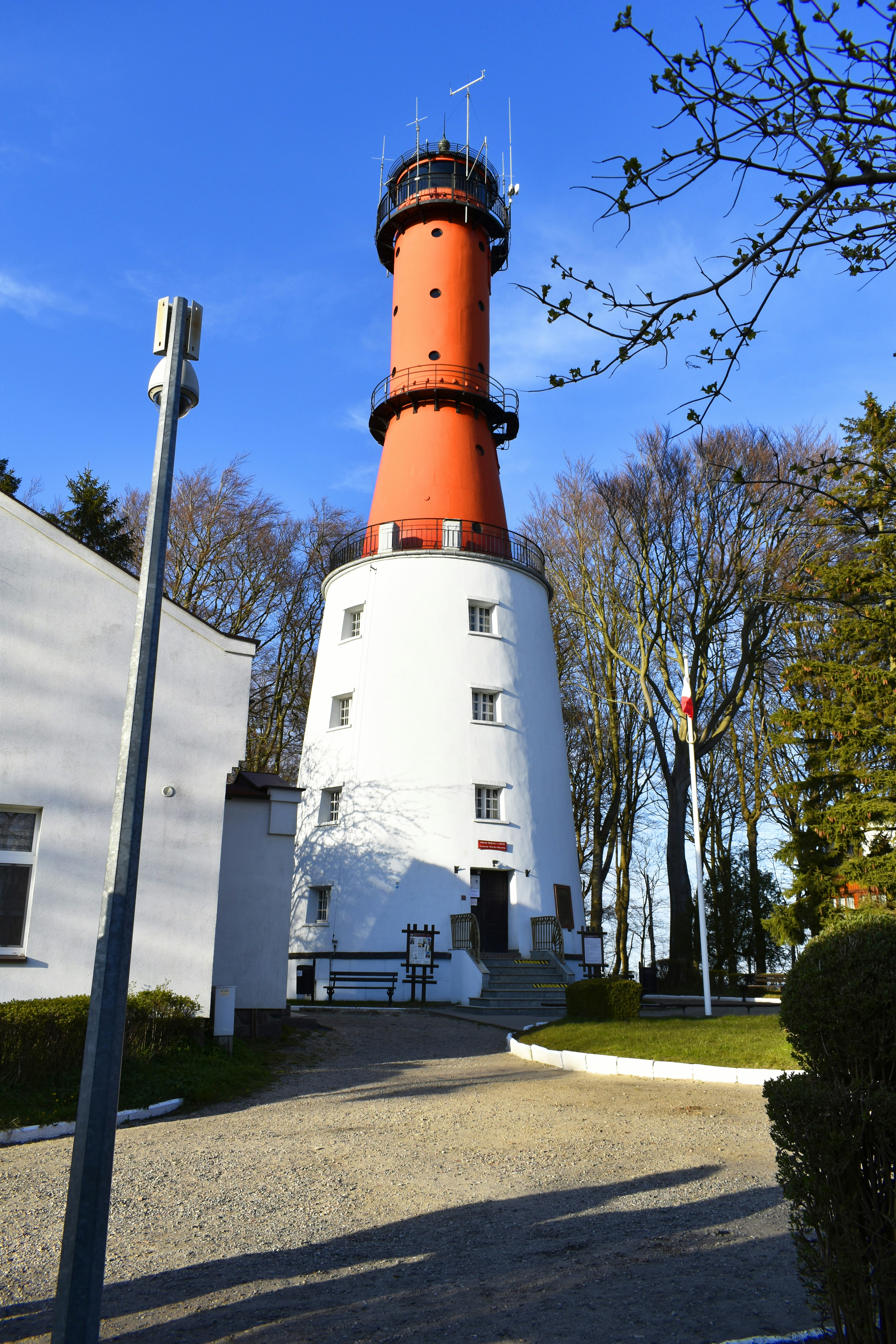 Beacon on a Clear Day: The Orange Tower Rising from a White Lighthouse