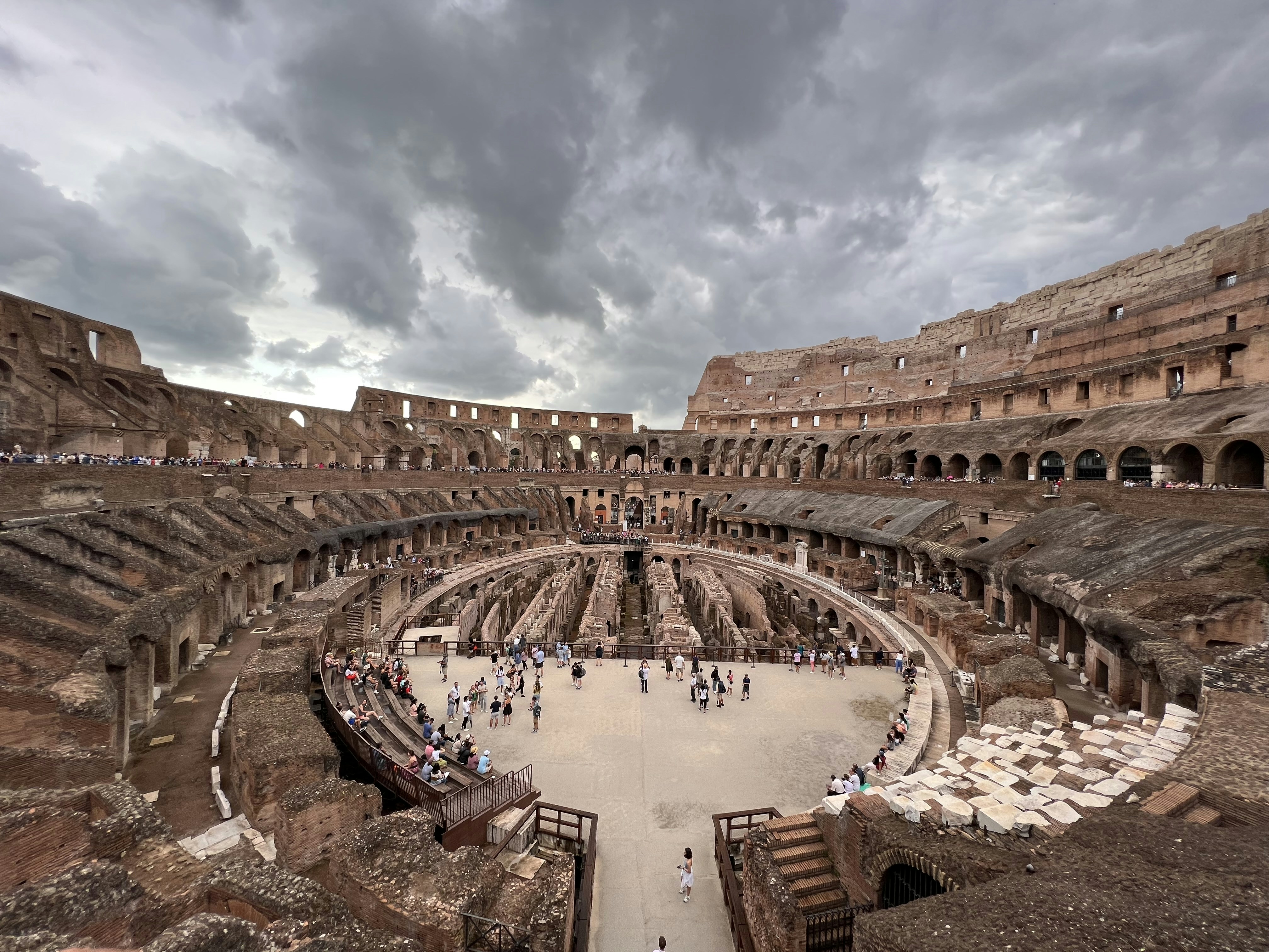 A group of people standing in a large building photo – Free Colosseum ...