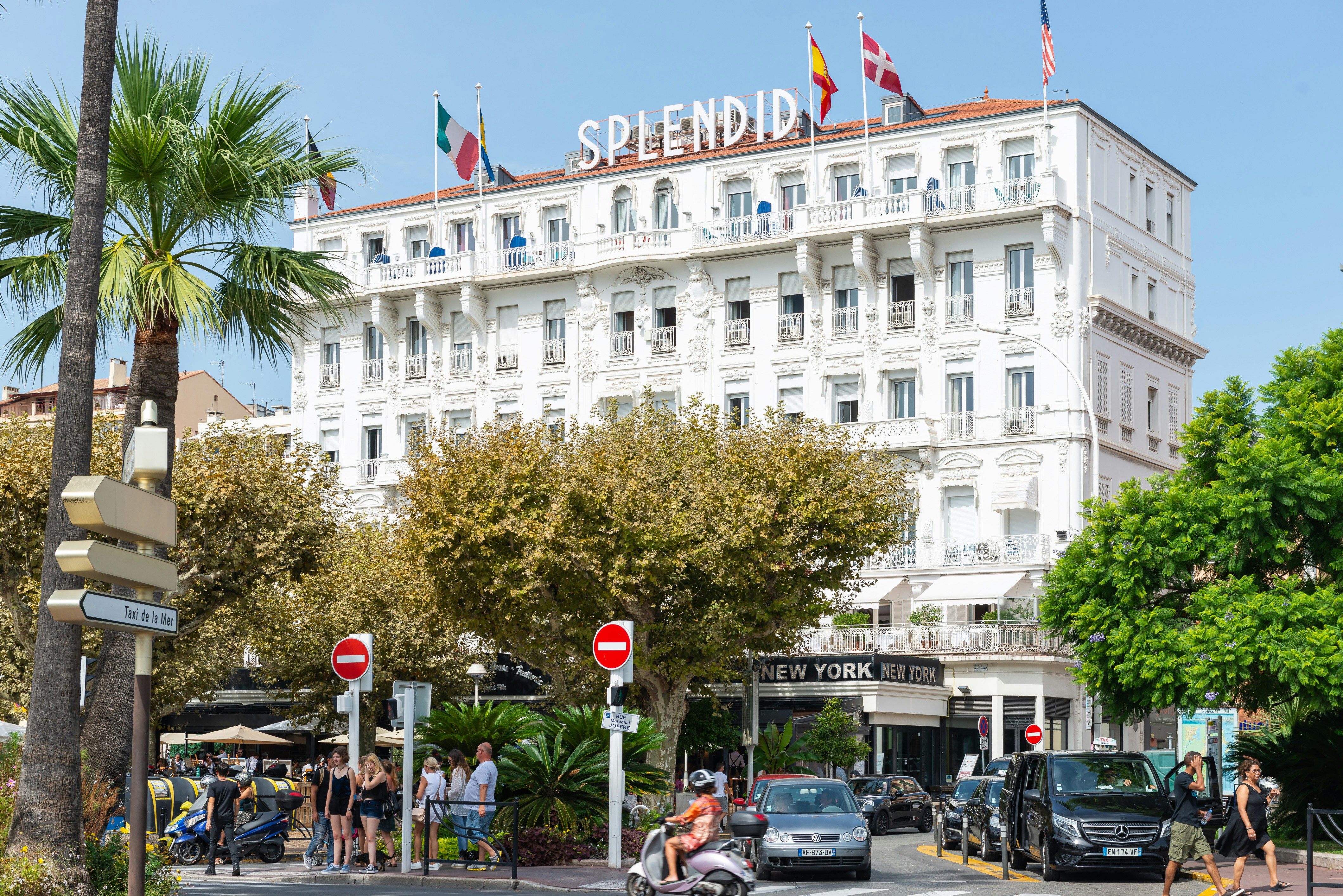 Splendid Hotel Facade on a Palm-Fringed, Sunlit Boulevard