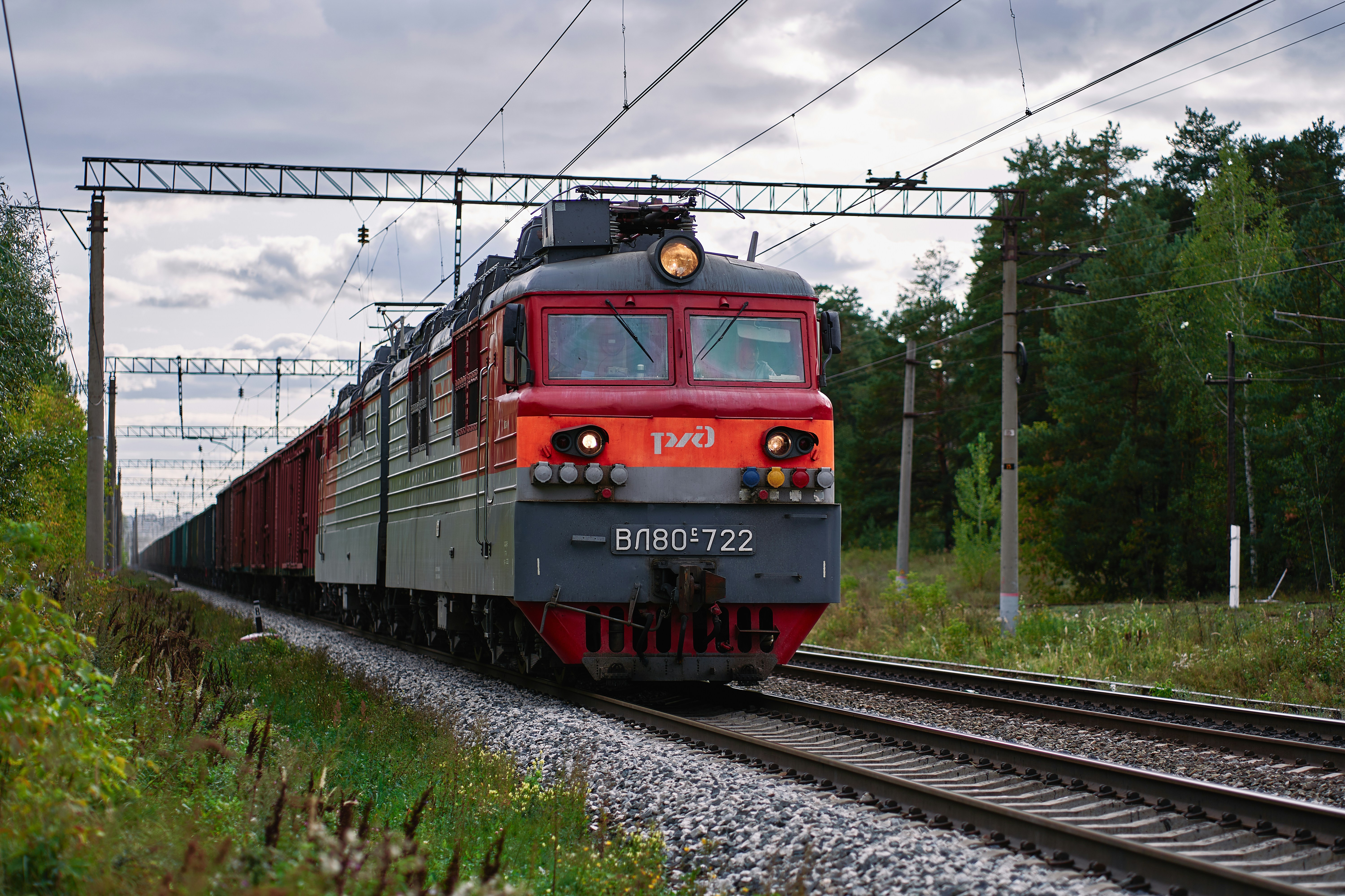 A red and grey train traveling down train tracks photo – Free Rail ...