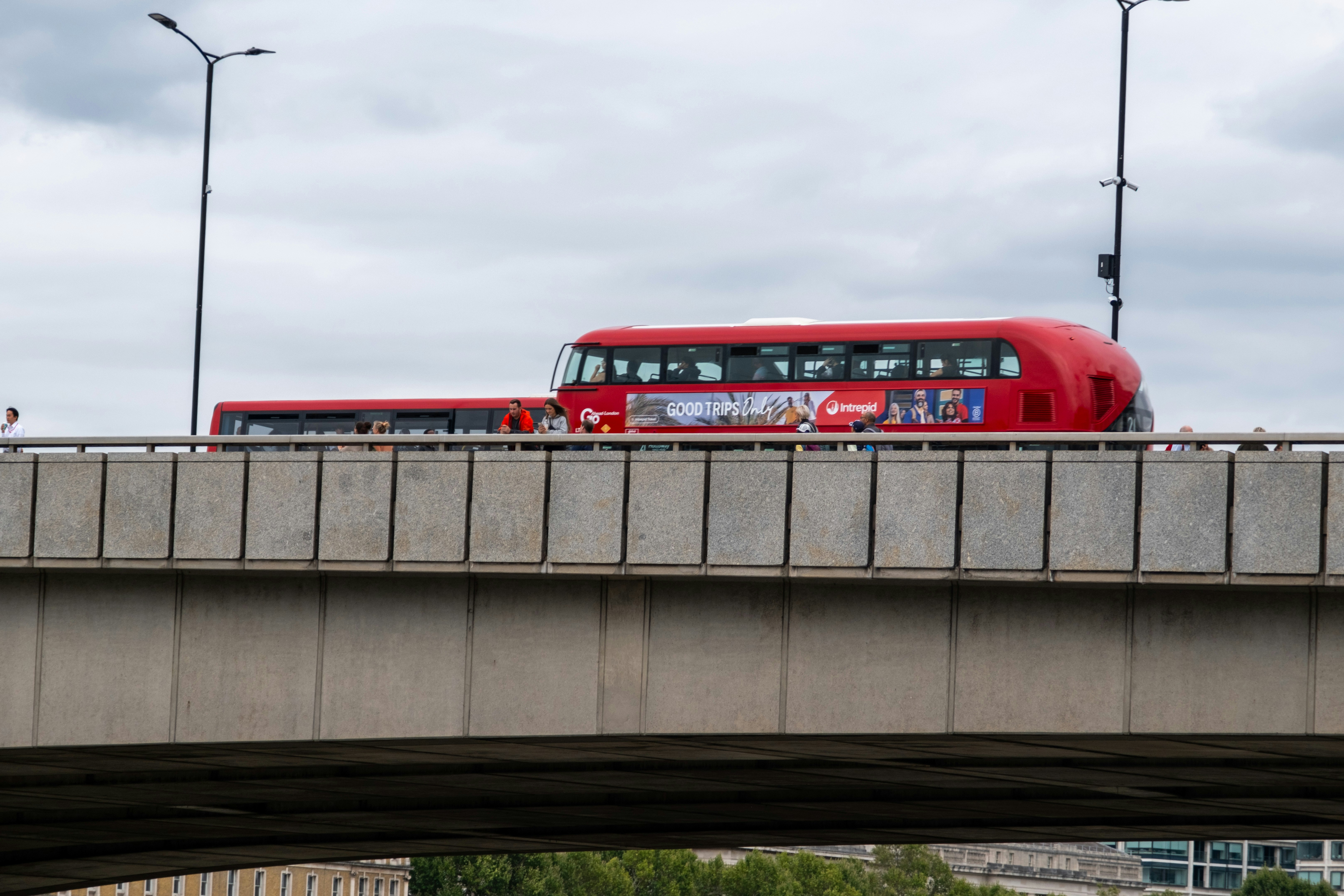 A red double decker bus driving over a bridge photo – Free London Image ...