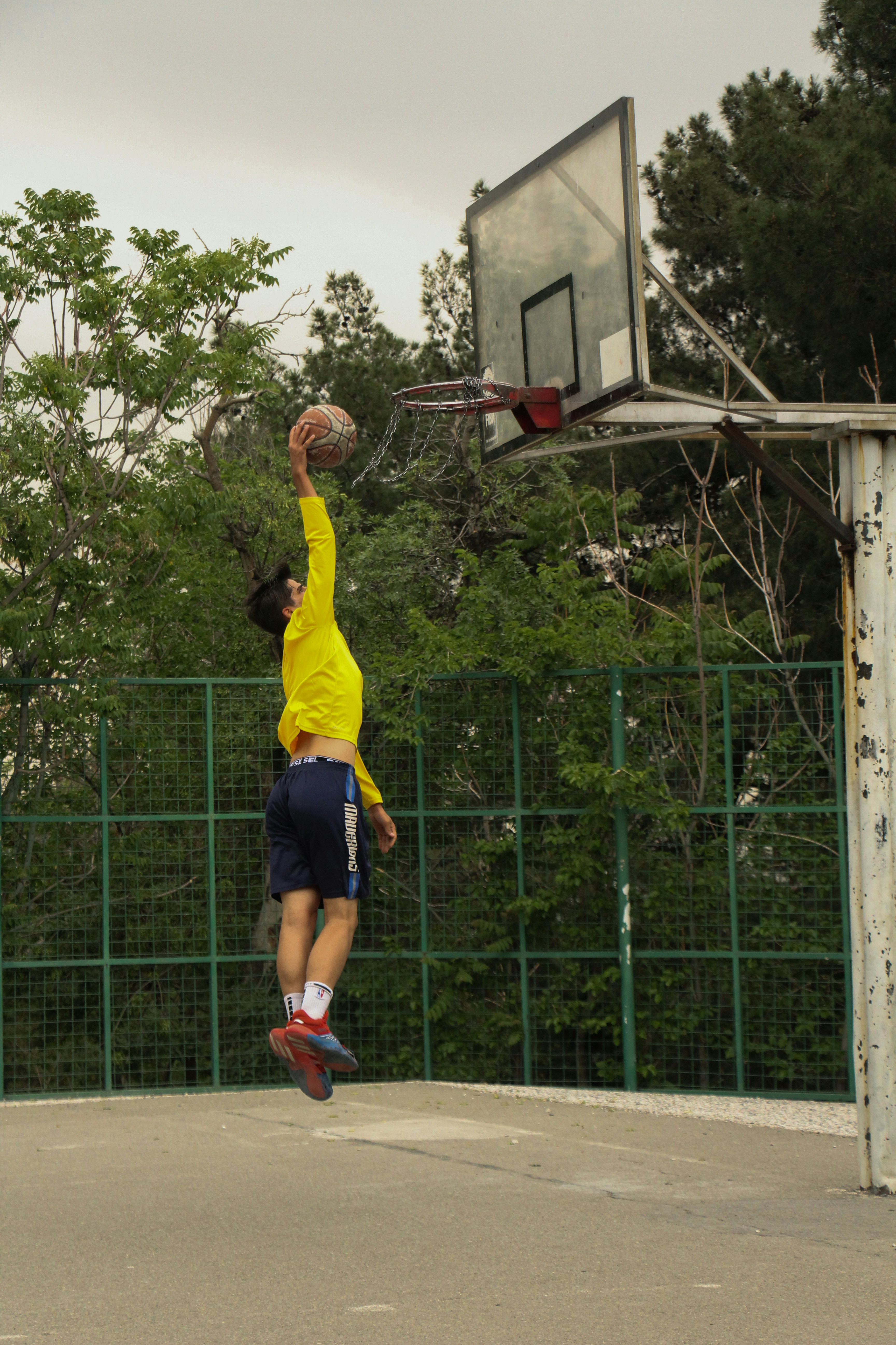 A man jumping up into the air to dunk a basketball photo – Free Tehran ...