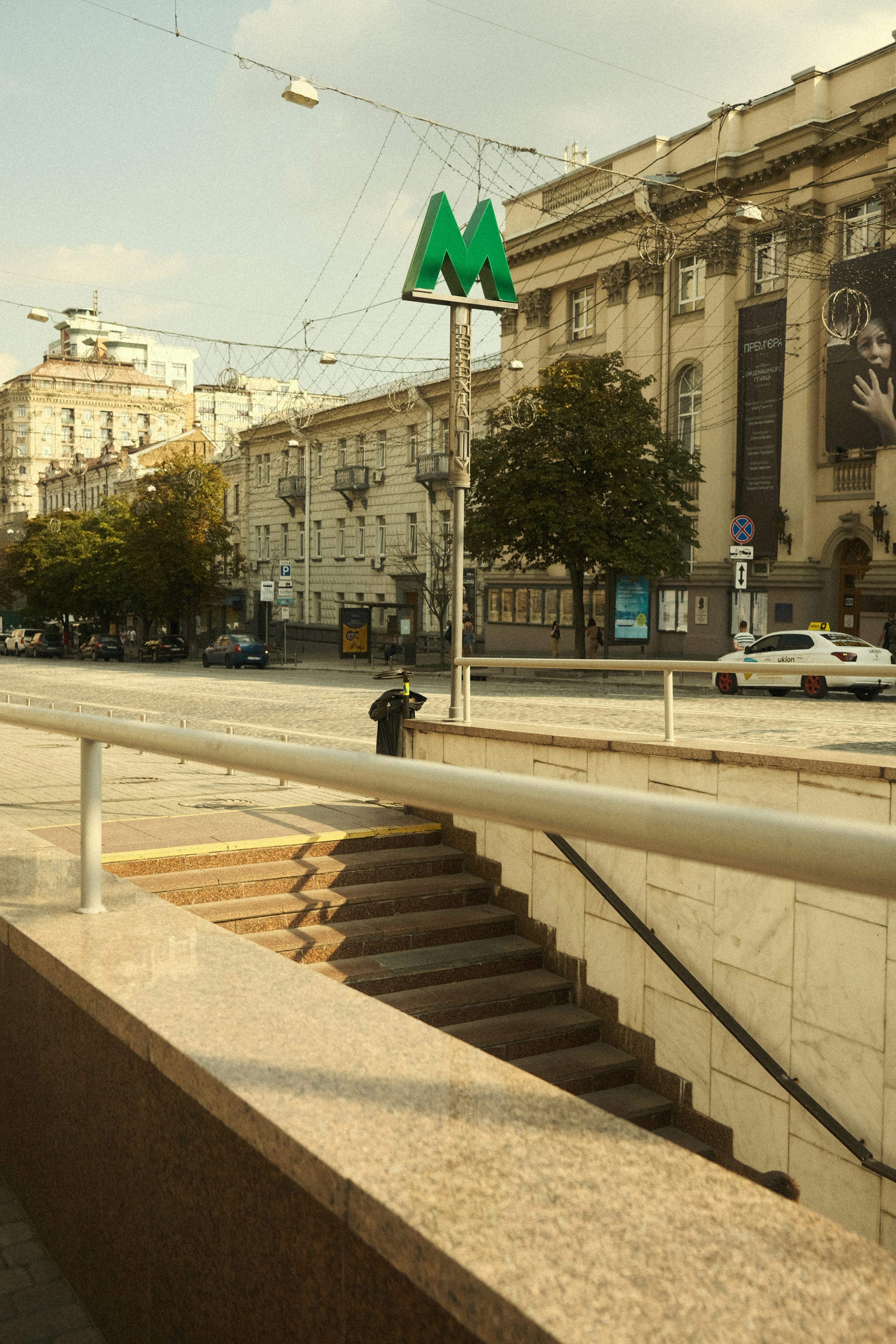 Green Metro Emblem Over Marble Stairs: A Quiet City Morning