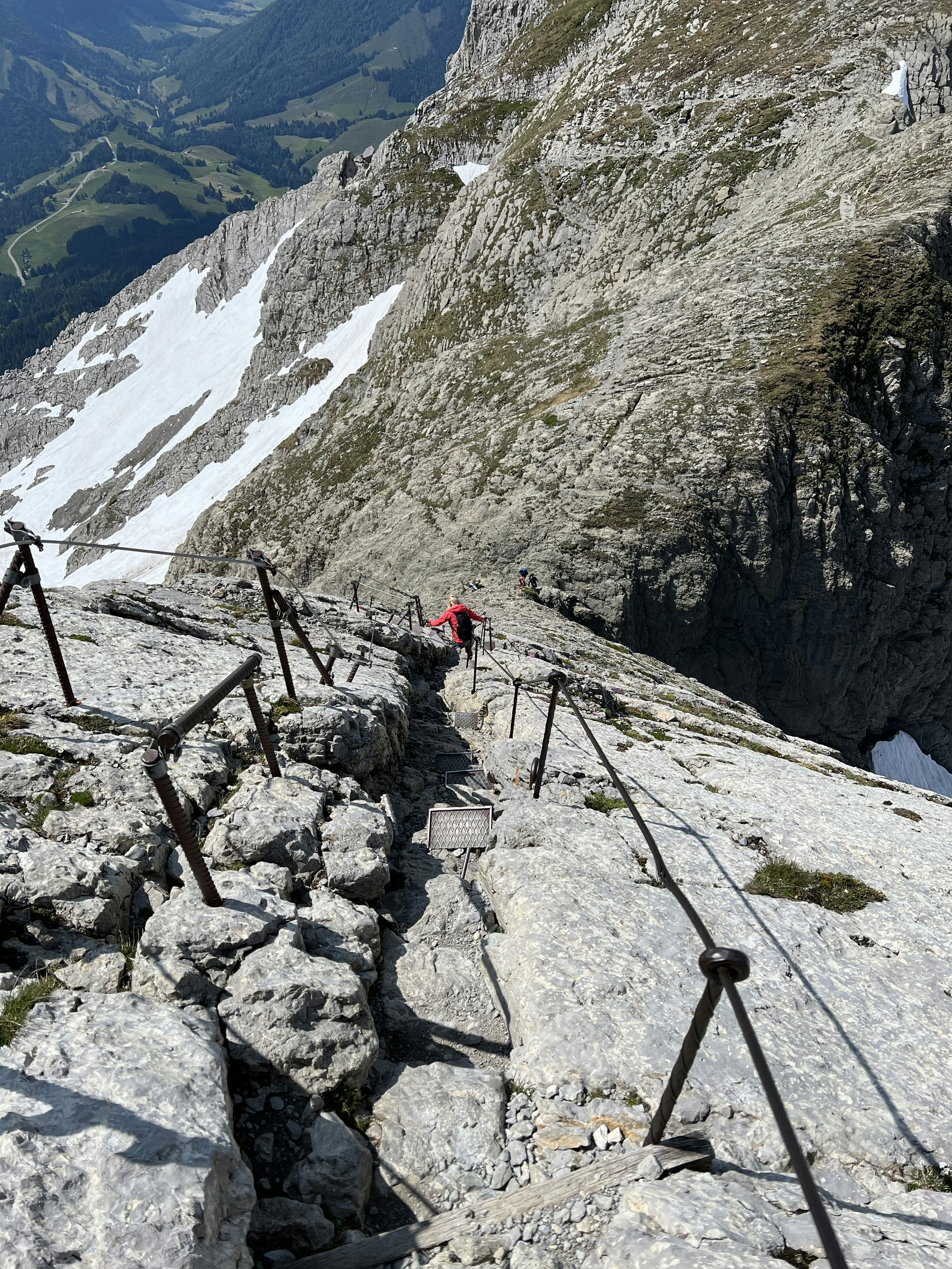 Red-Clad Climber on a Craggy Alpine Stairway