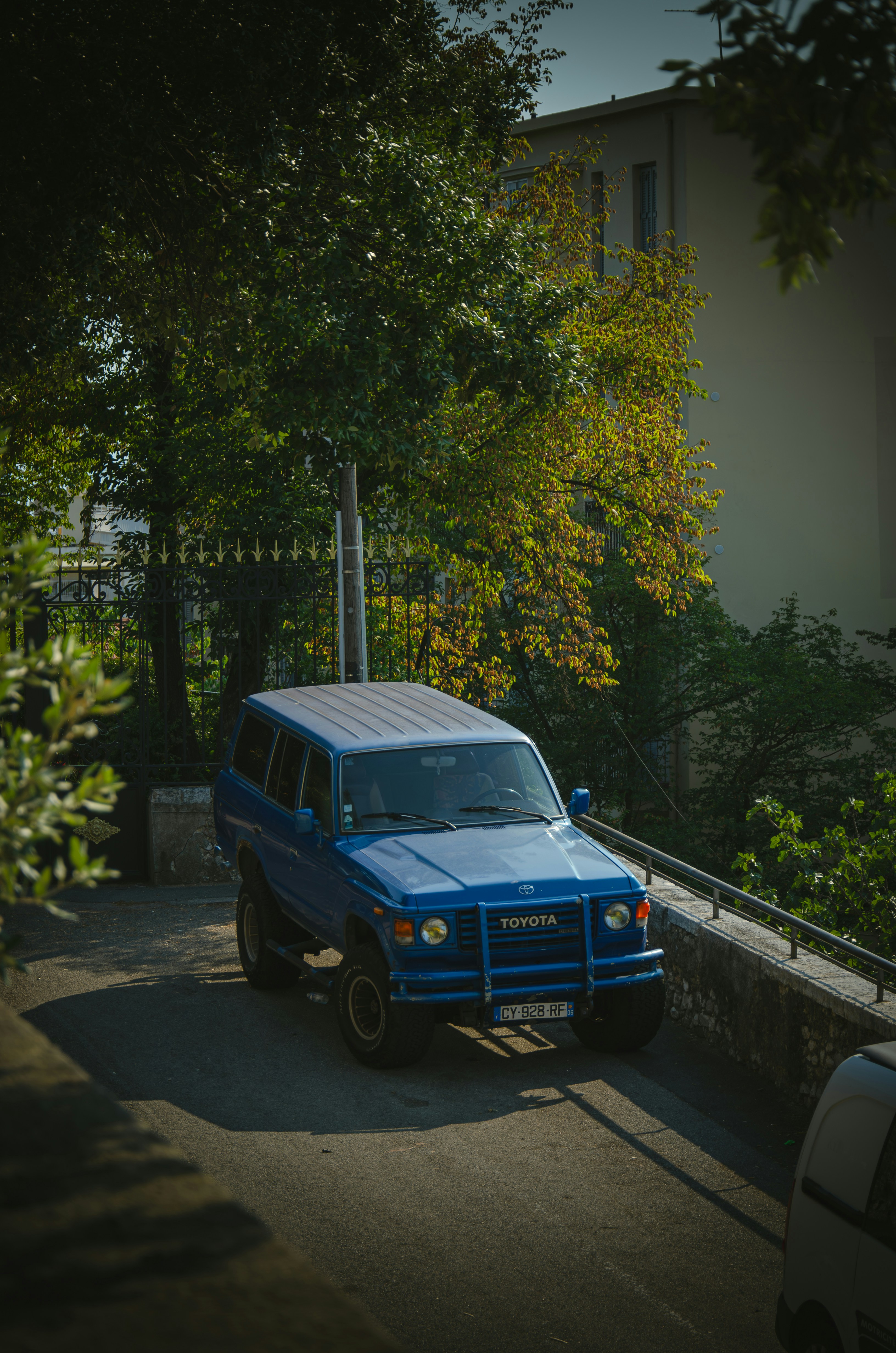 A blue jeep parked on the side of a road photo – Free France Image on ...