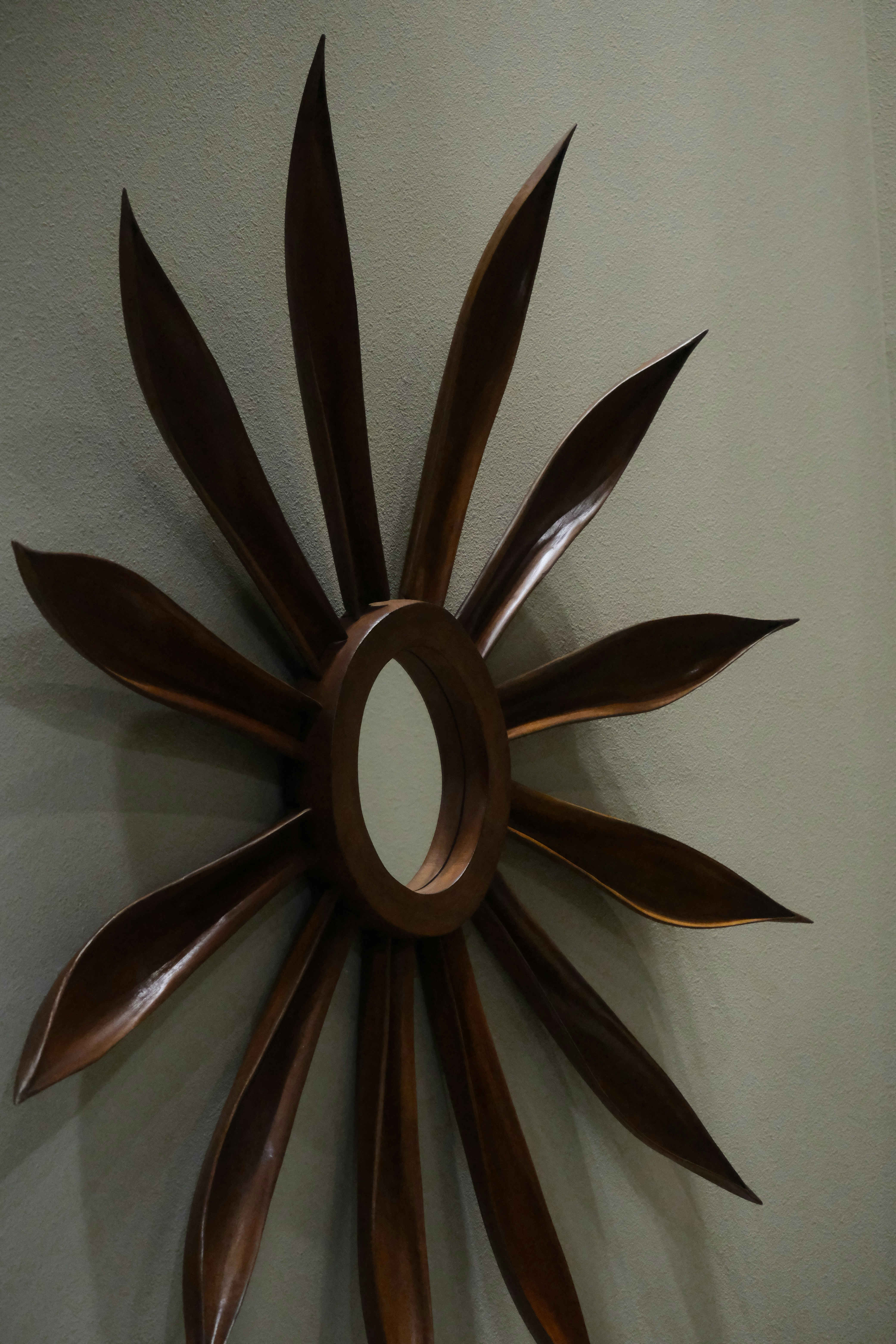 Copper Sunburst Mirror Reaching from a Serene Wall