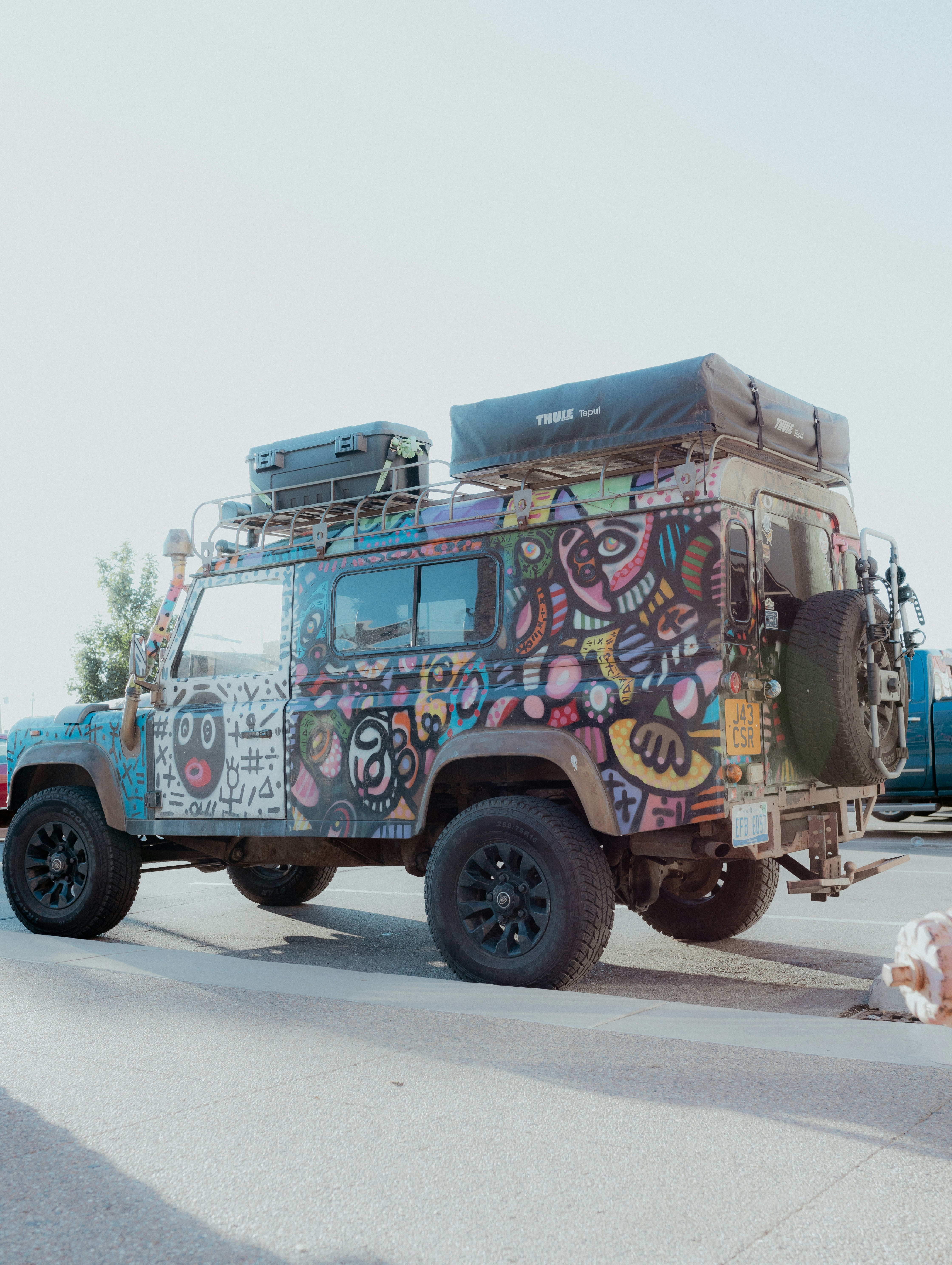 Graffiti Caravan: A Color-Splashed Expedition Van Anchored by Street Art