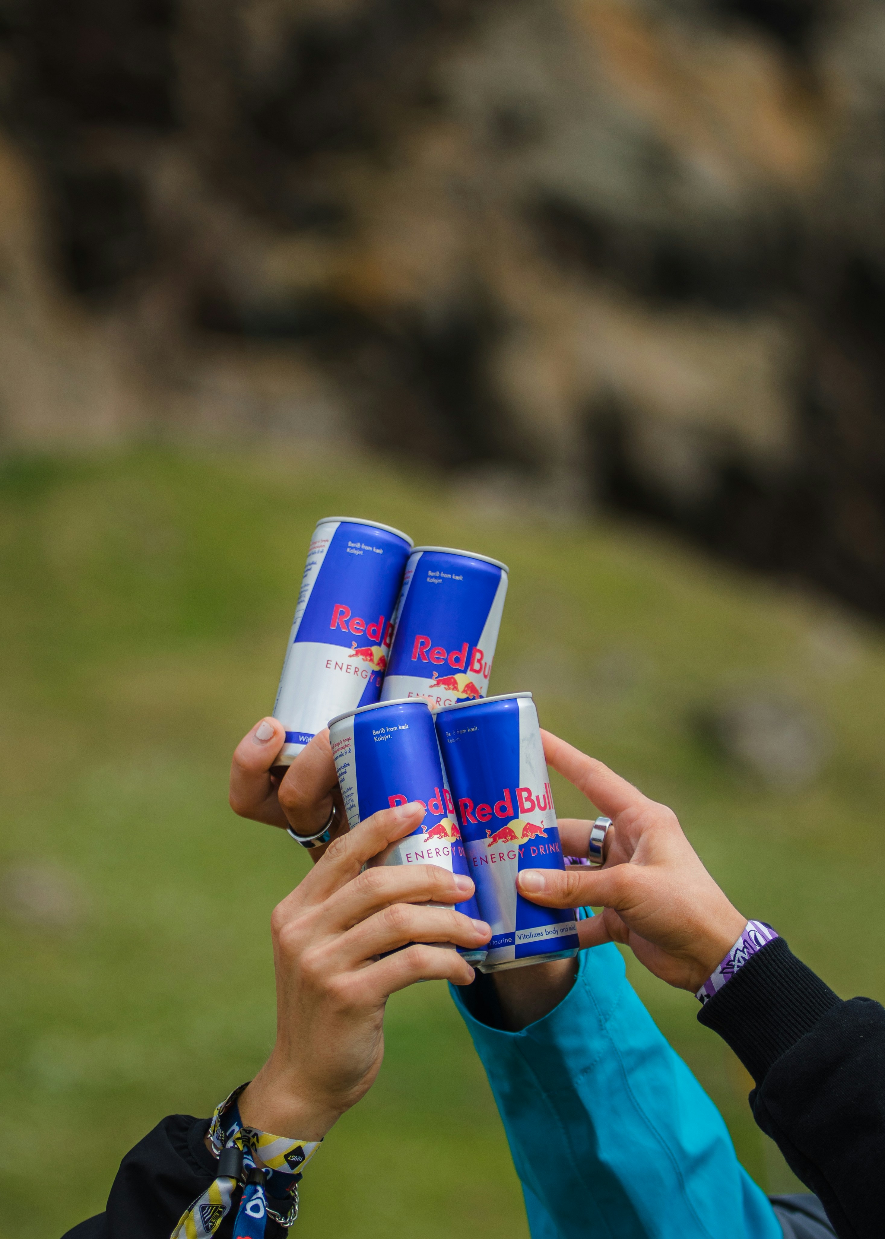 A group of people holding up cans of beer photo – Free Redbull Image on ...
