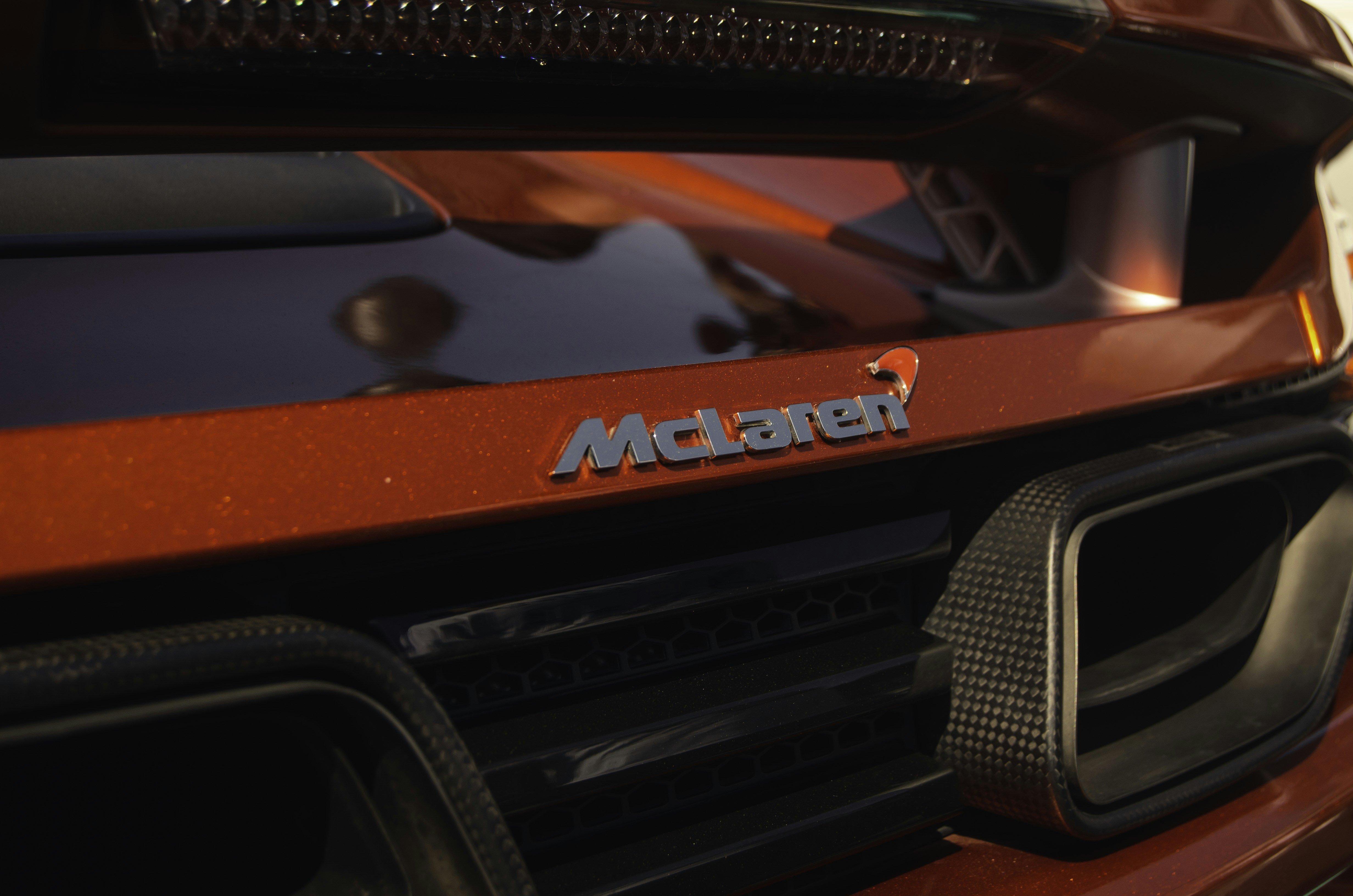 McLaren Emblem in Crimson: A Close-Up on Carbon-Fiber Grilles