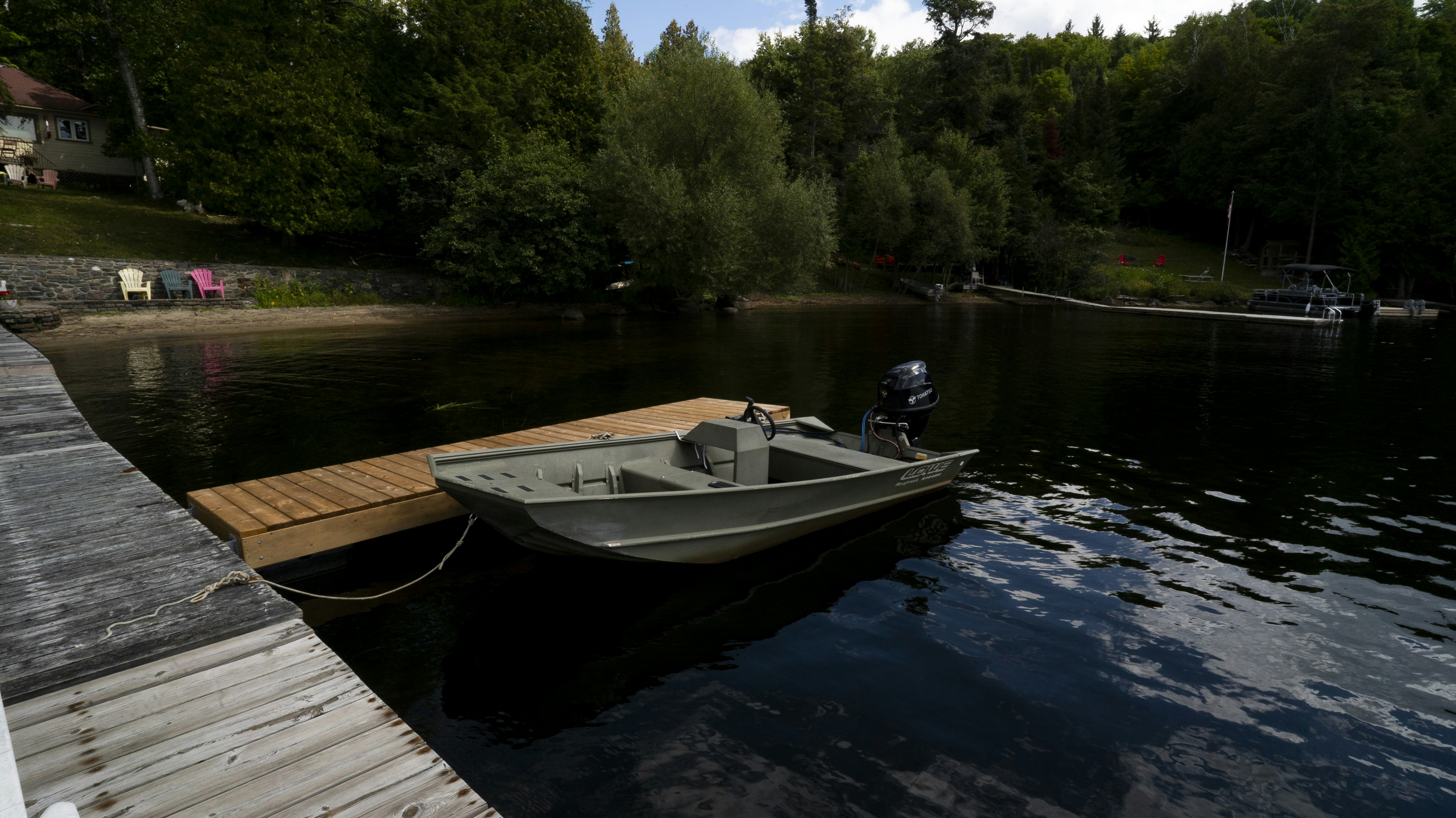 A small boat docked at a dock on a lake photo – Free Kashagawigamog ...